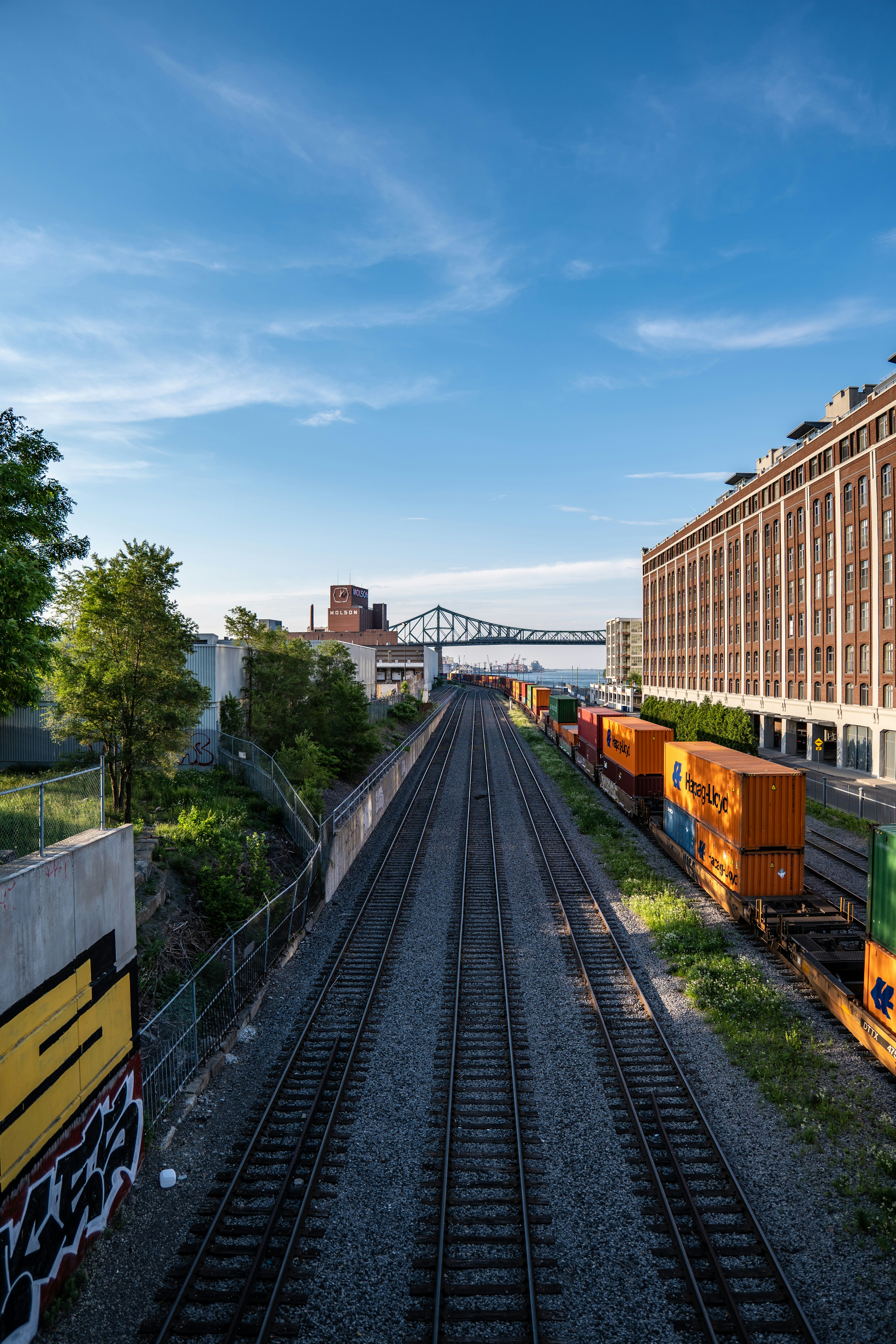 A train yard with a bridge in the background photo – Free Montreal ...