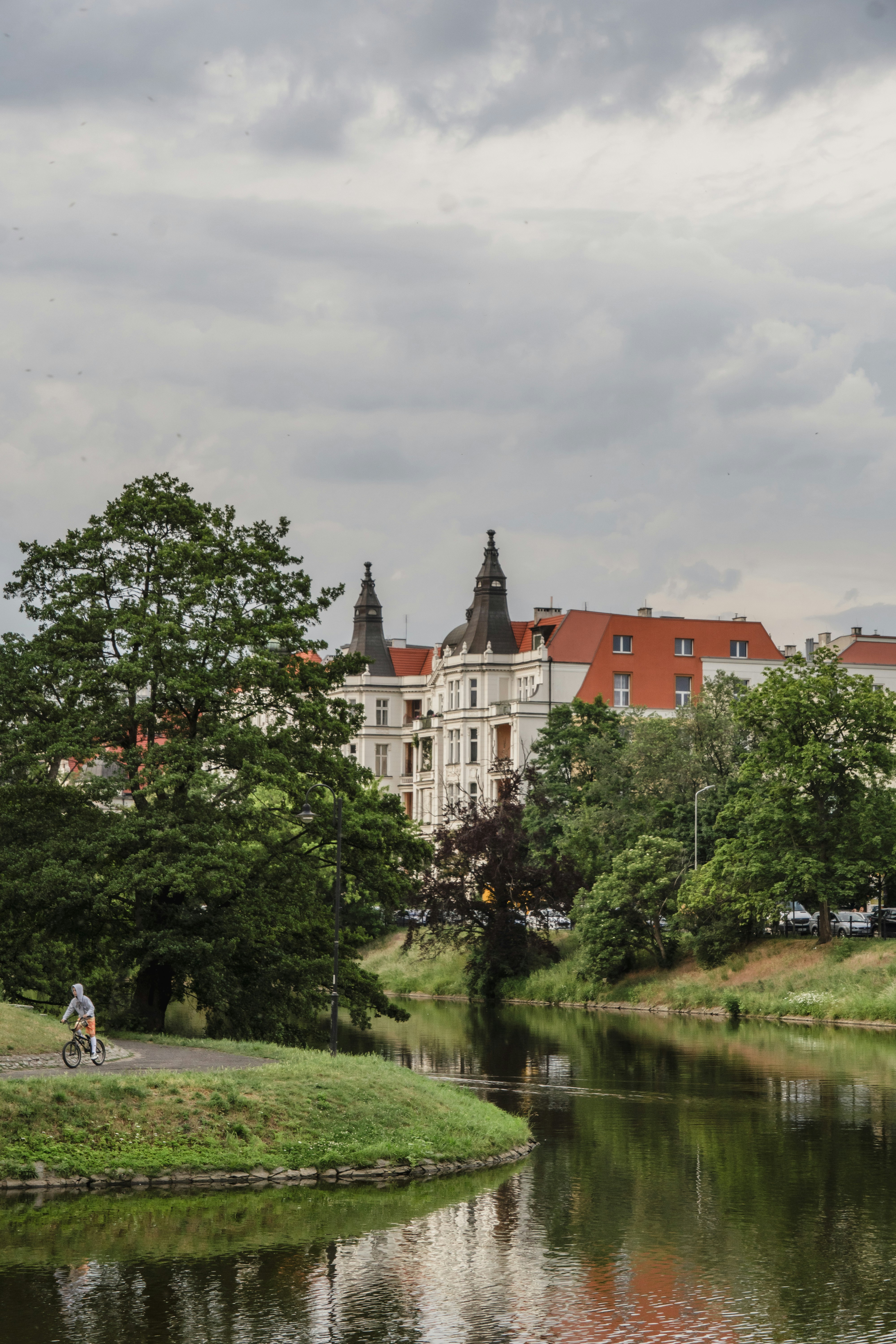 Riverside Calm: A Victorian Townscape Reflected in Tranquil Water