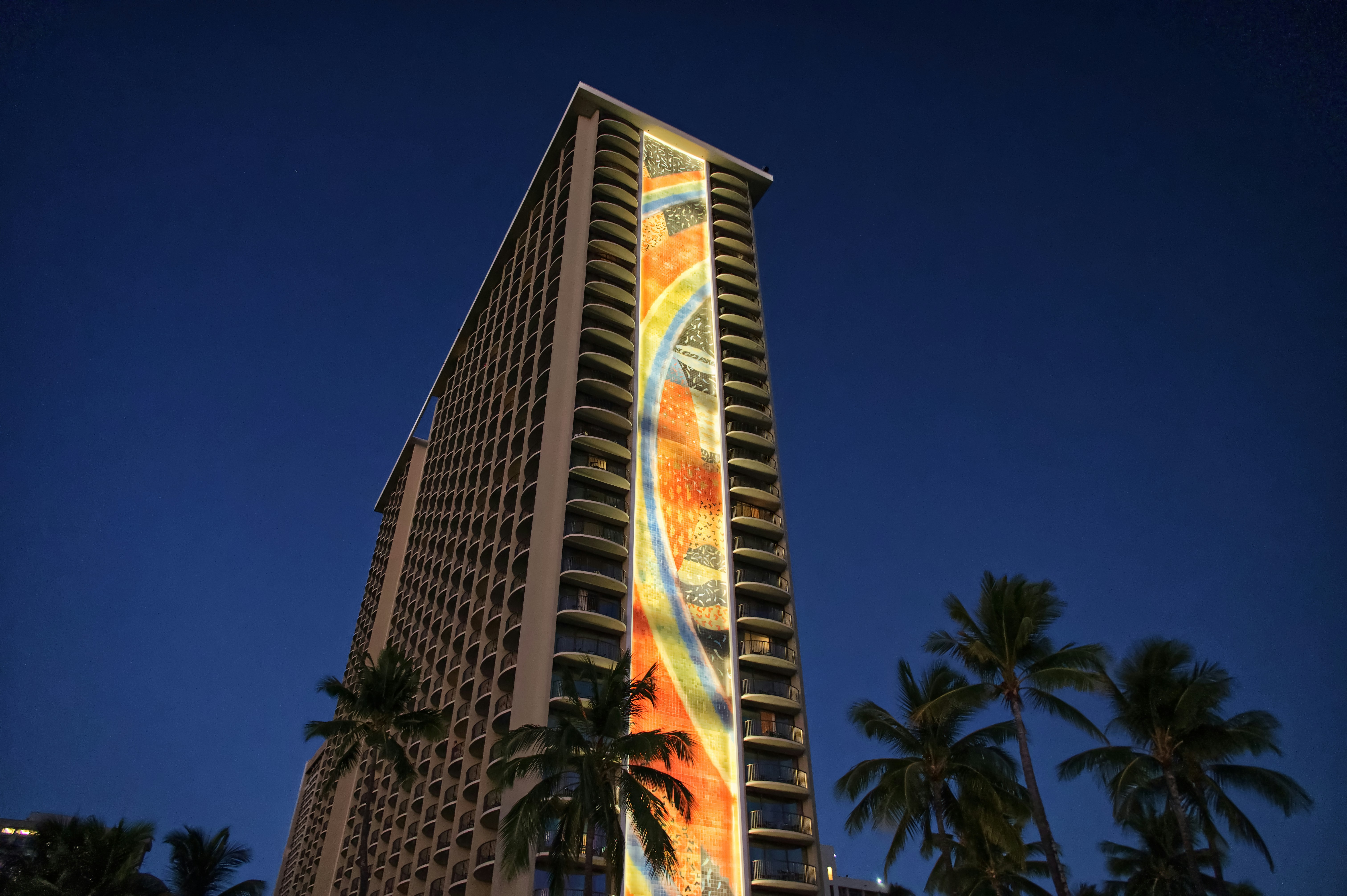 Night Mosaic Descends a Palm-Fringed Tower