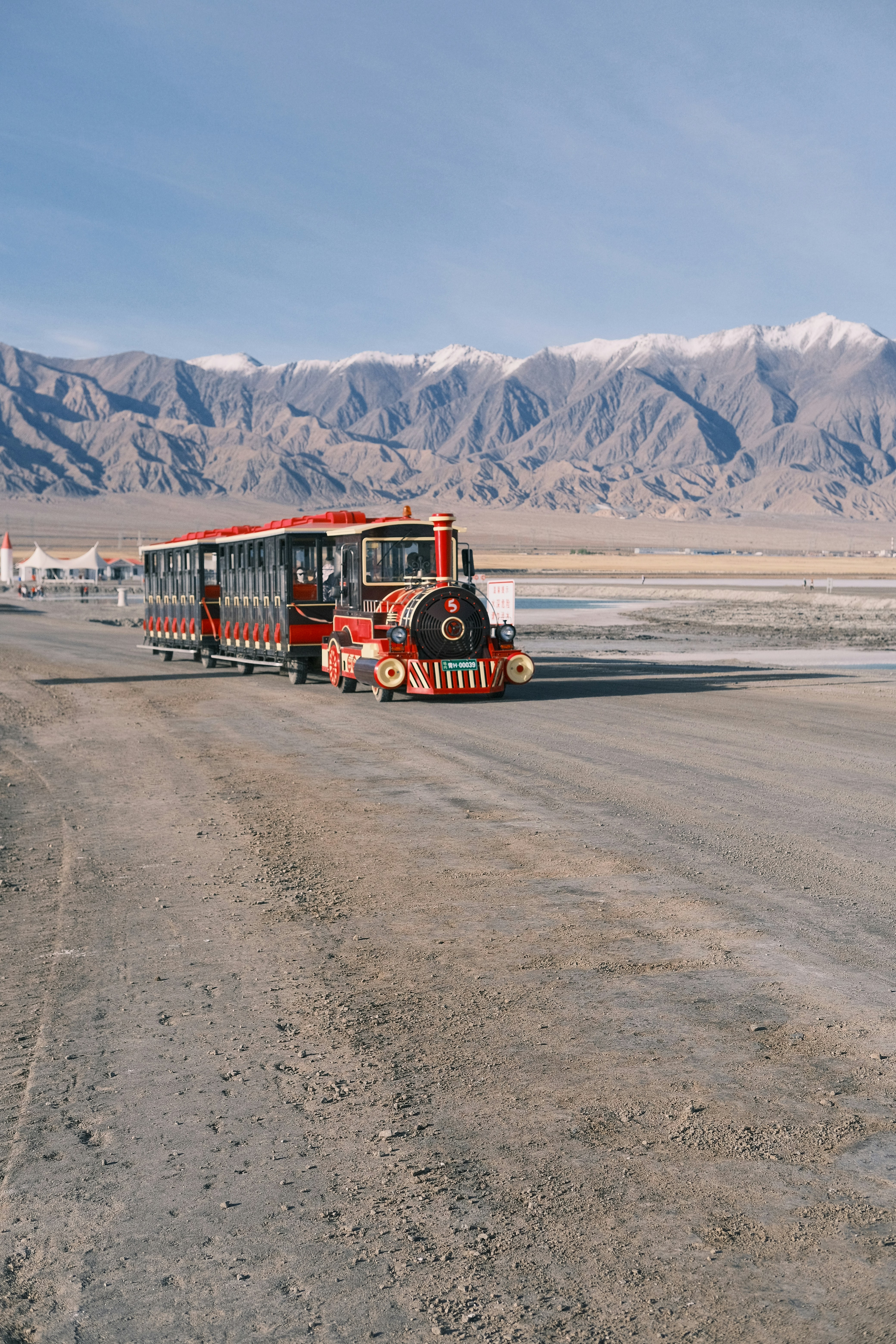 In this captivating image, a vibrant red firetruck stands out boldly against the backdrop of an arid, desolate landscape.