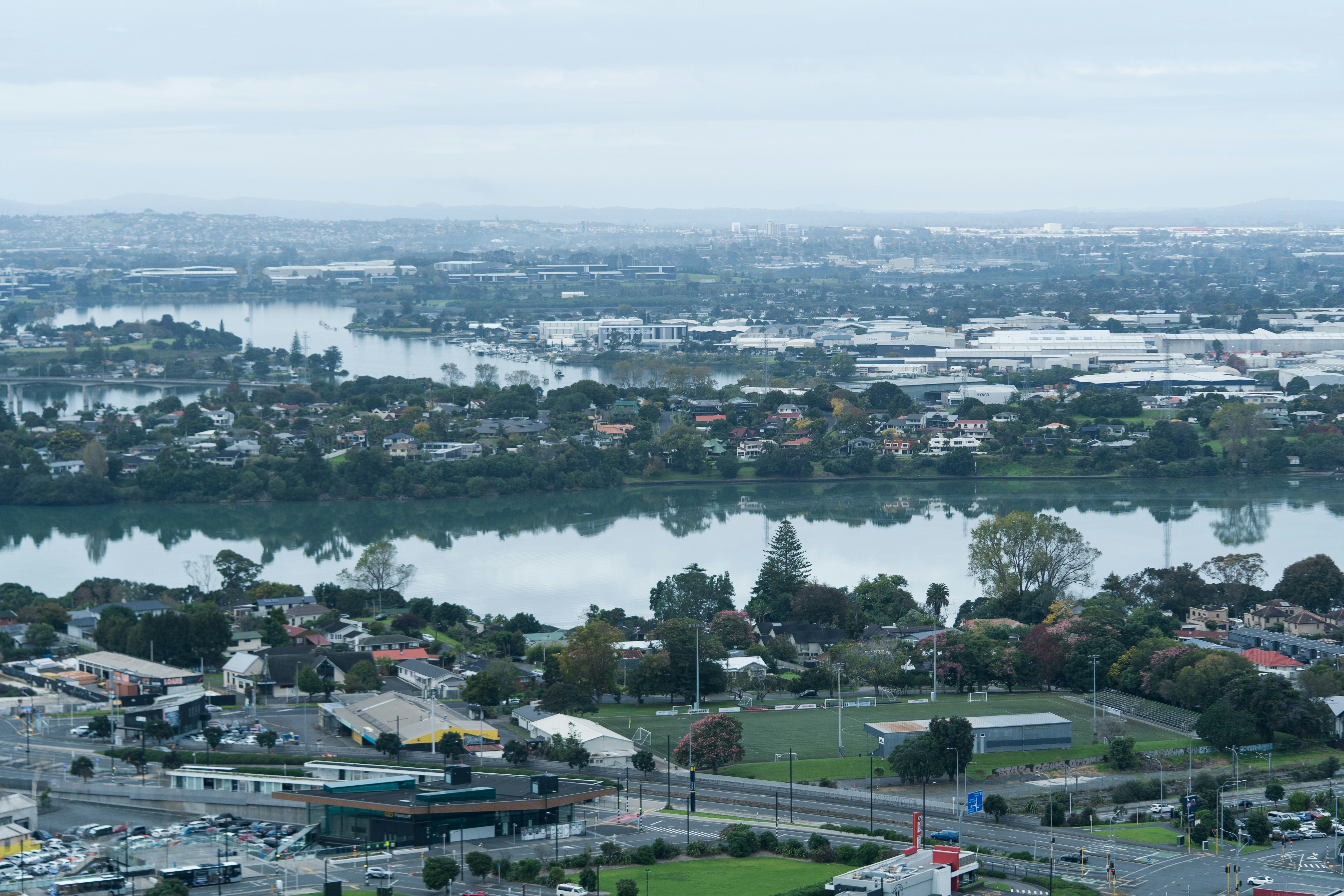 An aerial view of a city with a lake in the background photo – Free ...