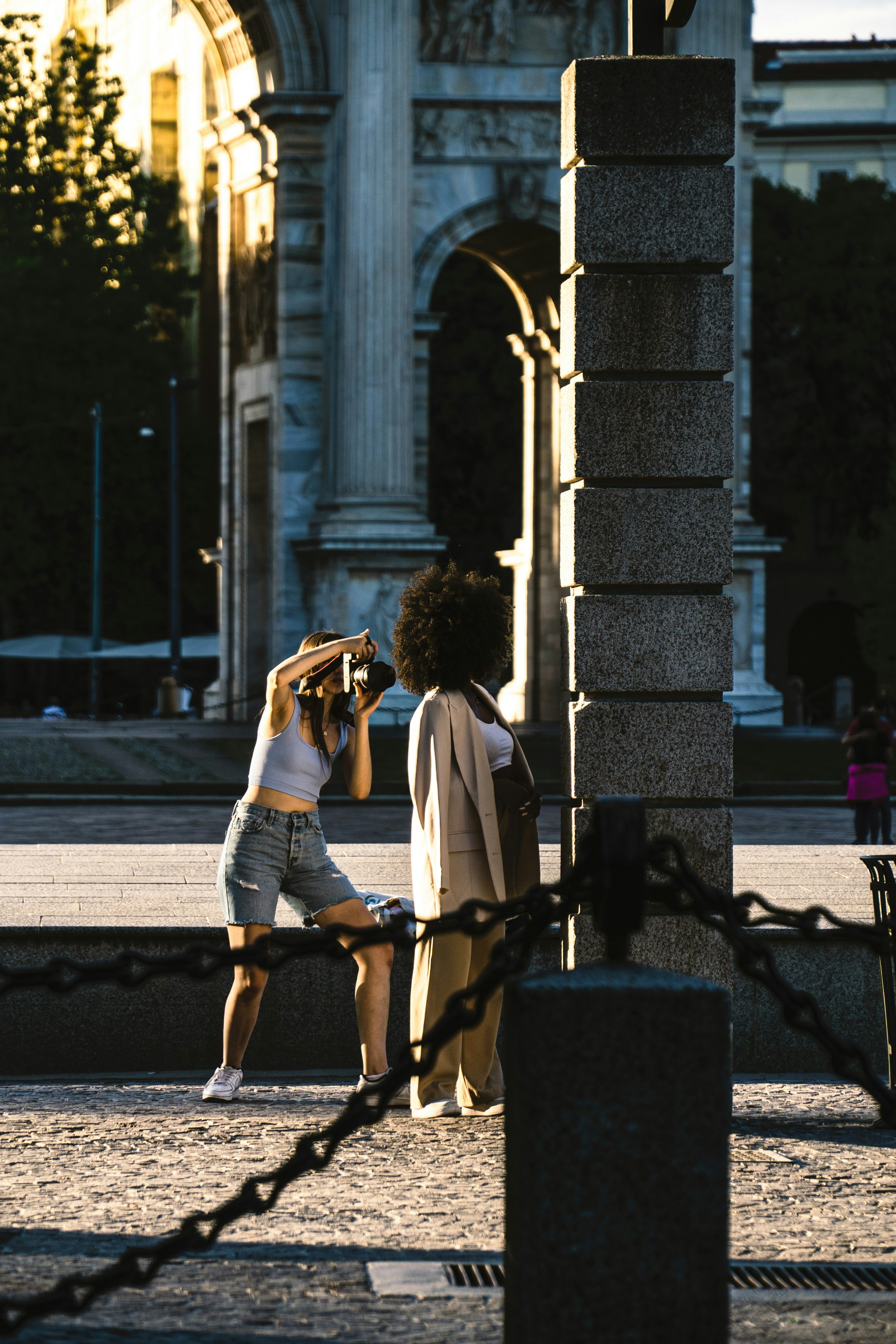 Photographer in Action: Capturing a Moment by the Historic Arch