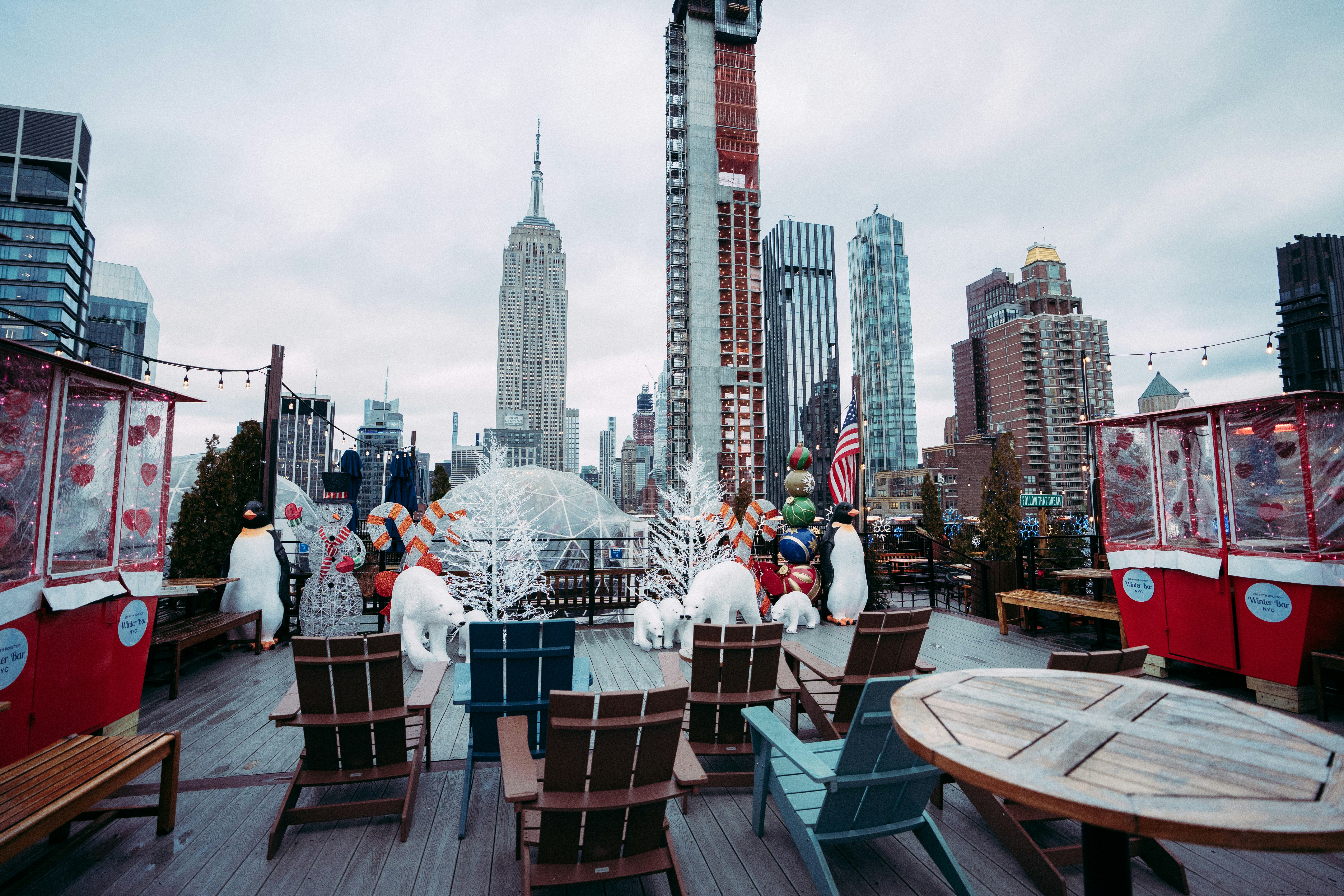 Ice Carousel on a Winter Rooftop Amid a Glass City Skyline