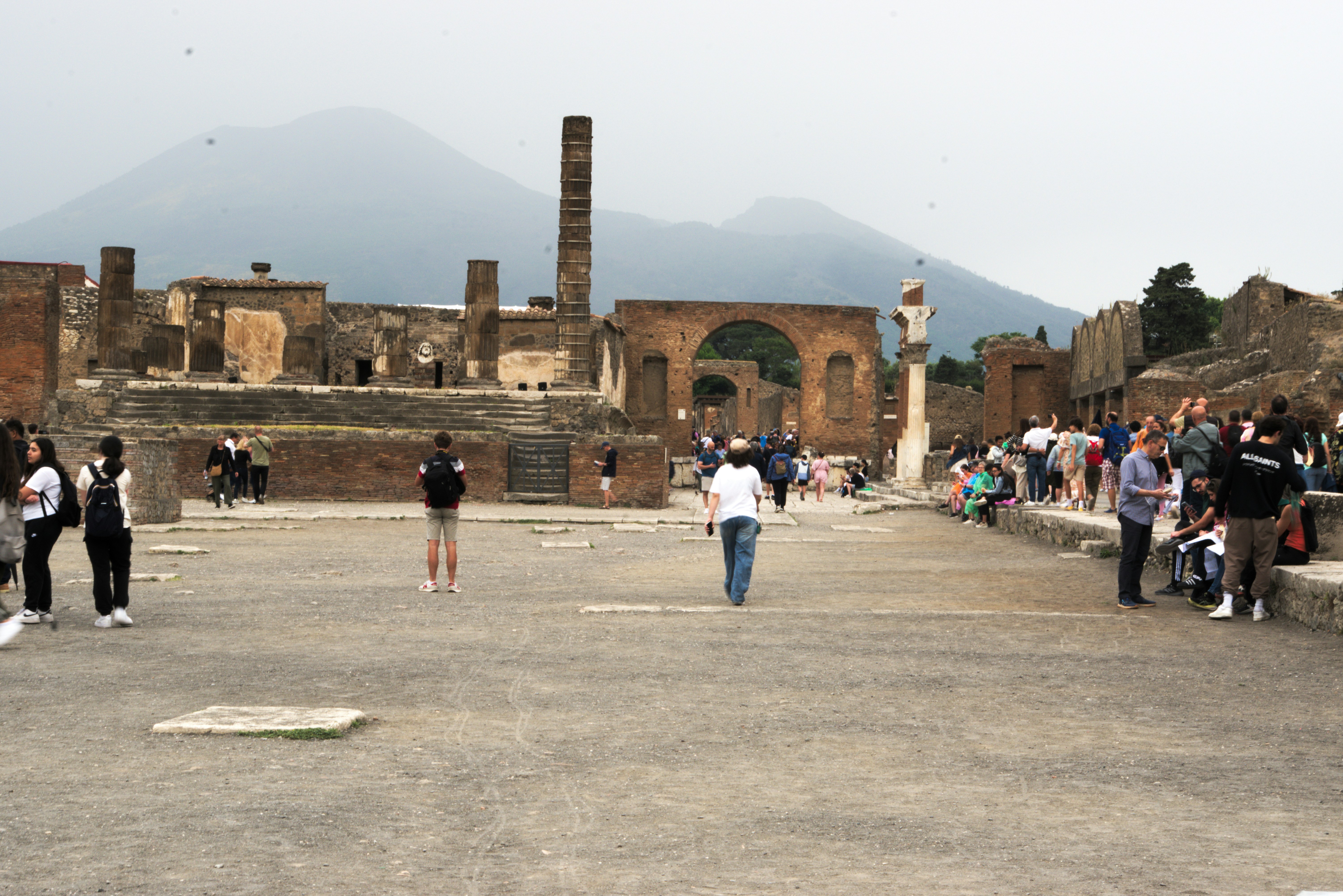 Ruins and Visitors under a Mountain Veil