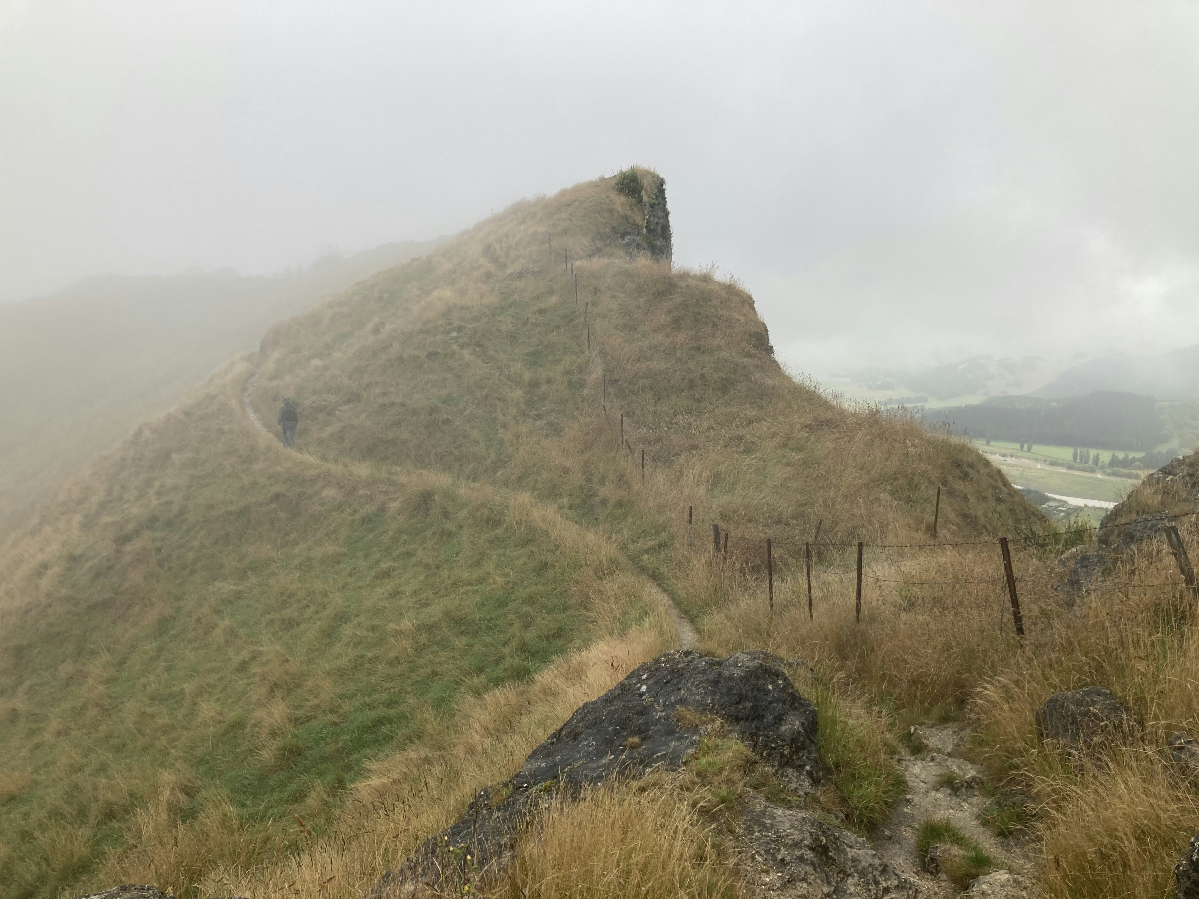 Mist-Clad Promontory: A Winding Ridge Toward the Exposed Summit