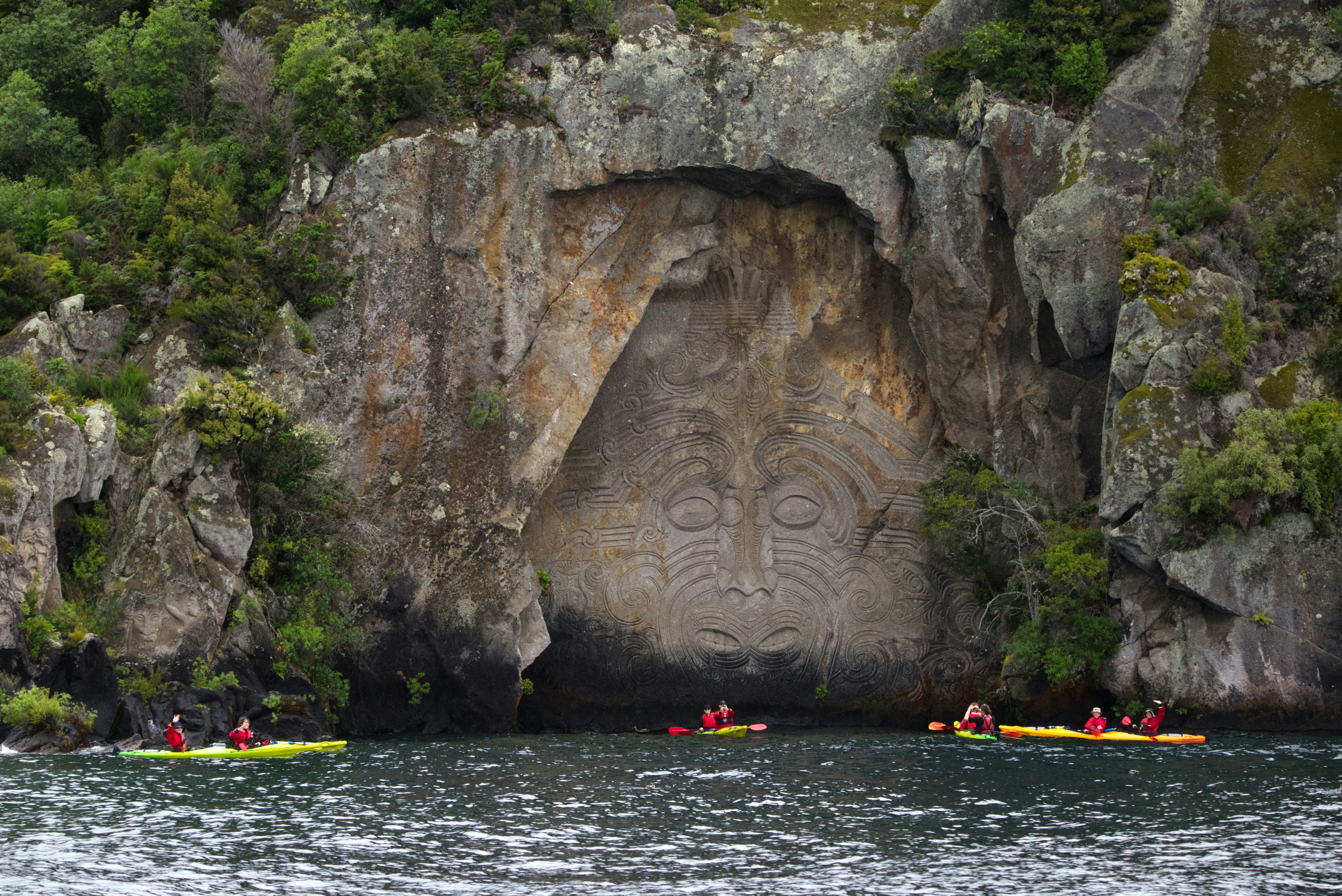 Concentric Face of the Gorge: Kayaks Gather at the Carved Portal