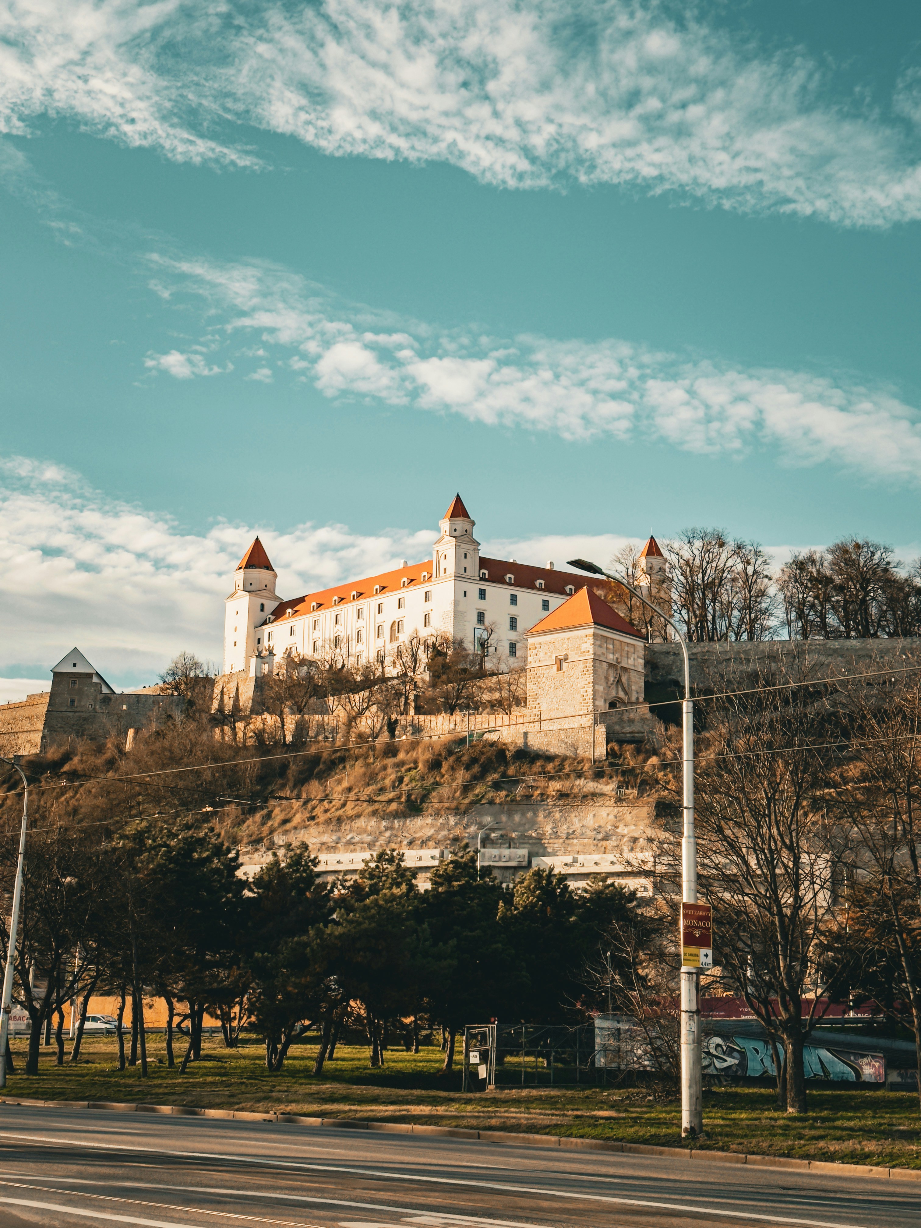 A large white castle sitting on top of a hill photo – Free Bratislava ...