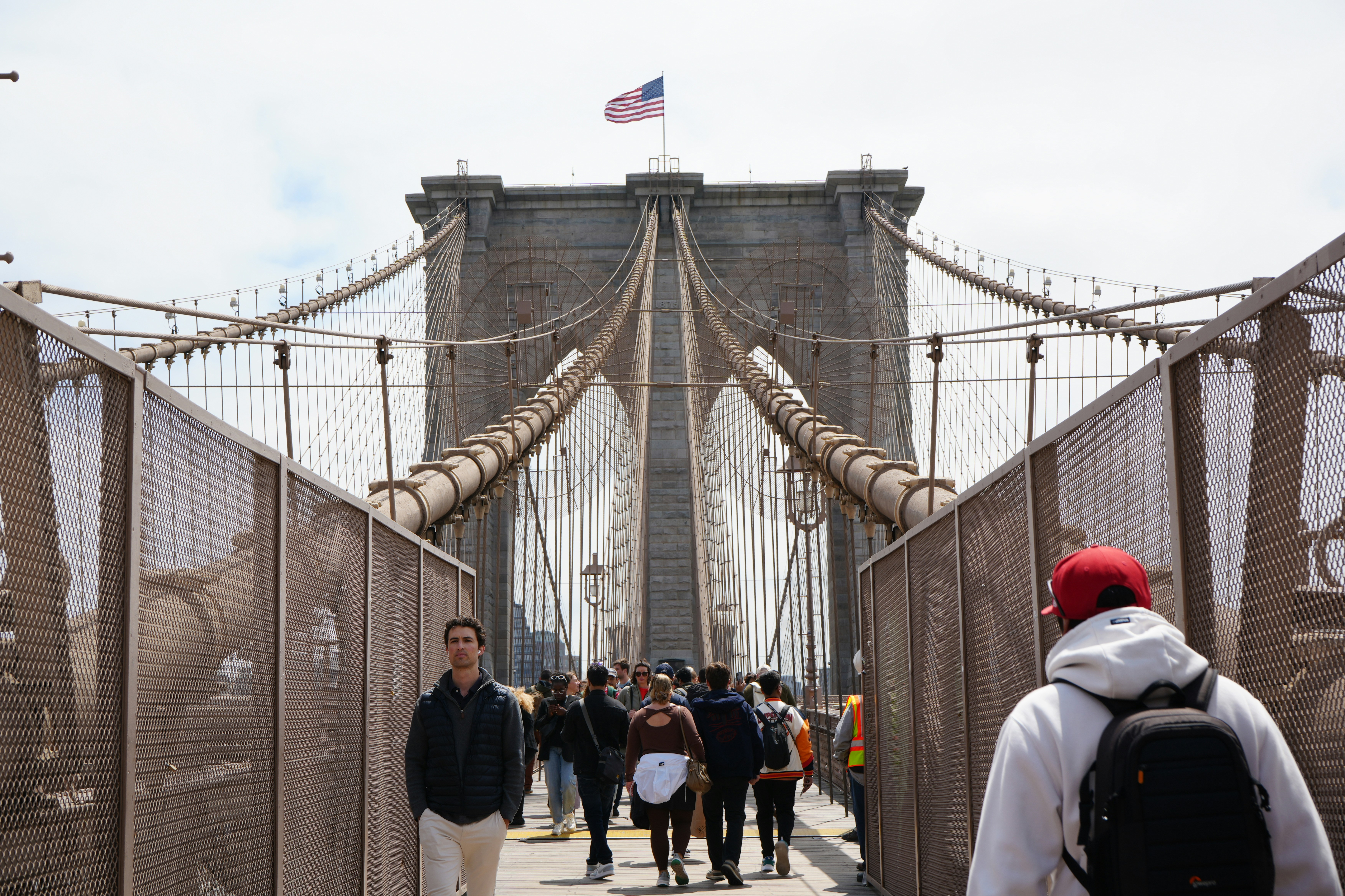 A group of people walking across a bridge photo – Free New york Image ...