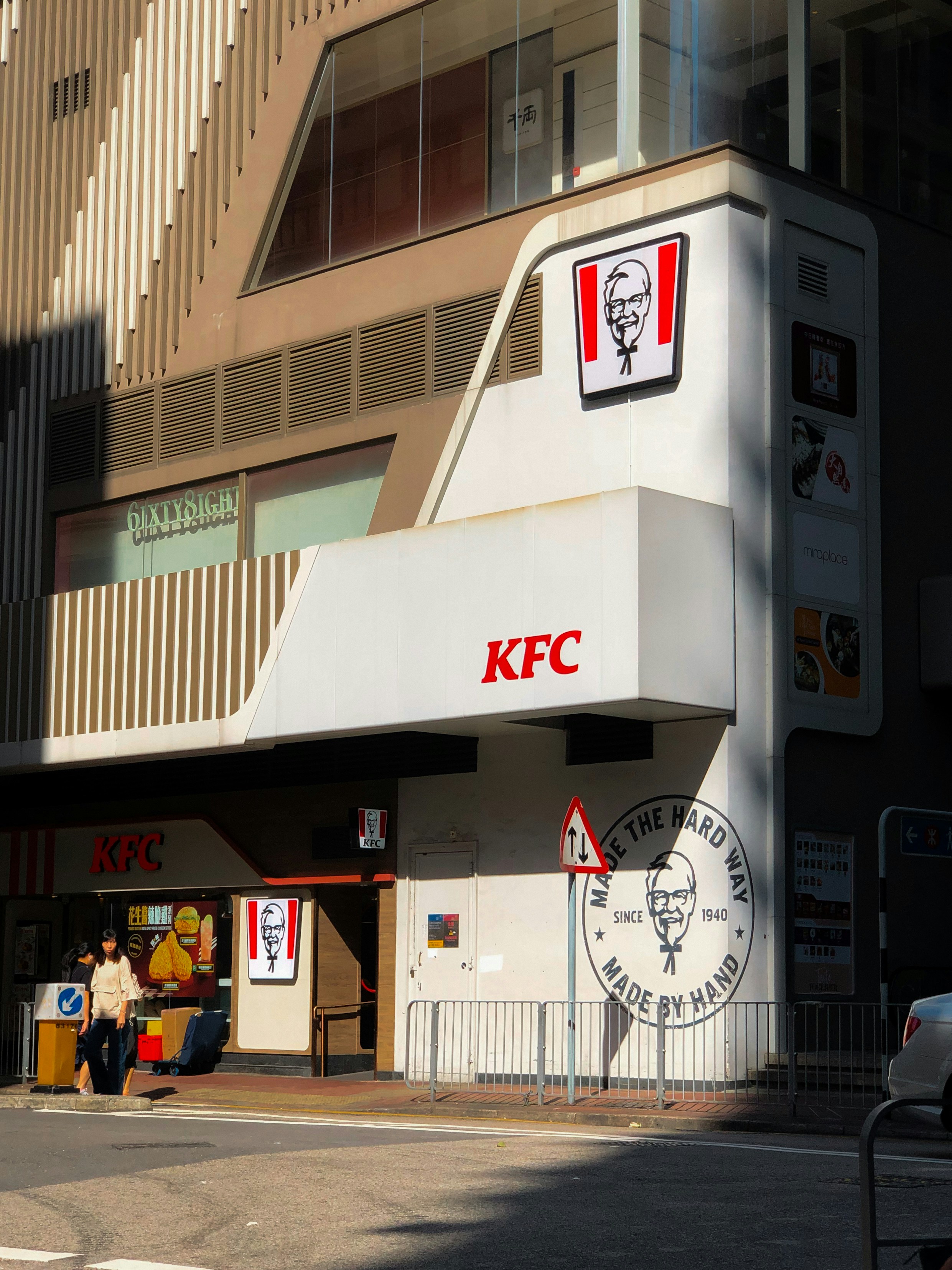 KFC Corner: Neon Red Sign Over Busy Street