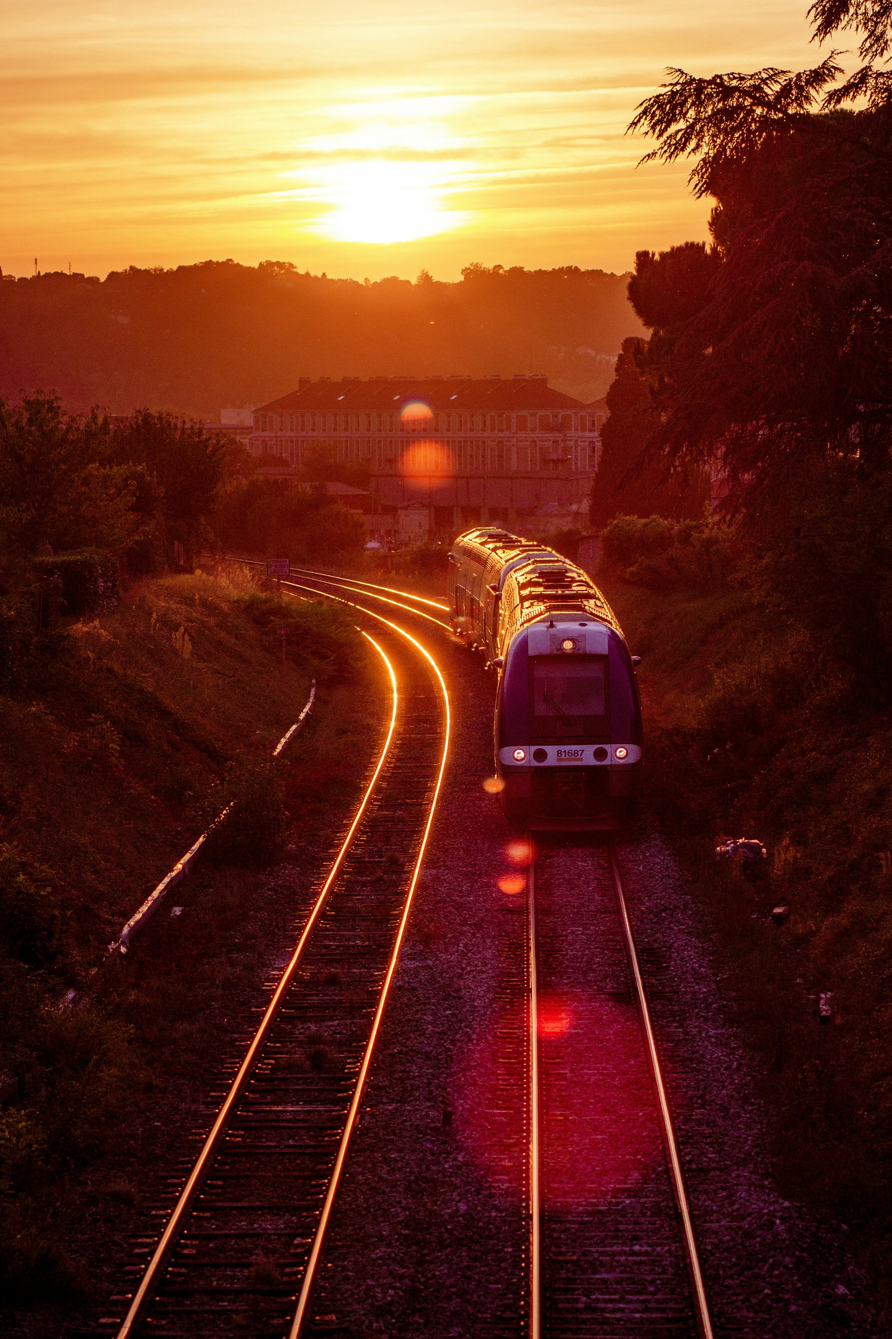 Dusk Rails: The Glowing Train on Sunset Tracks