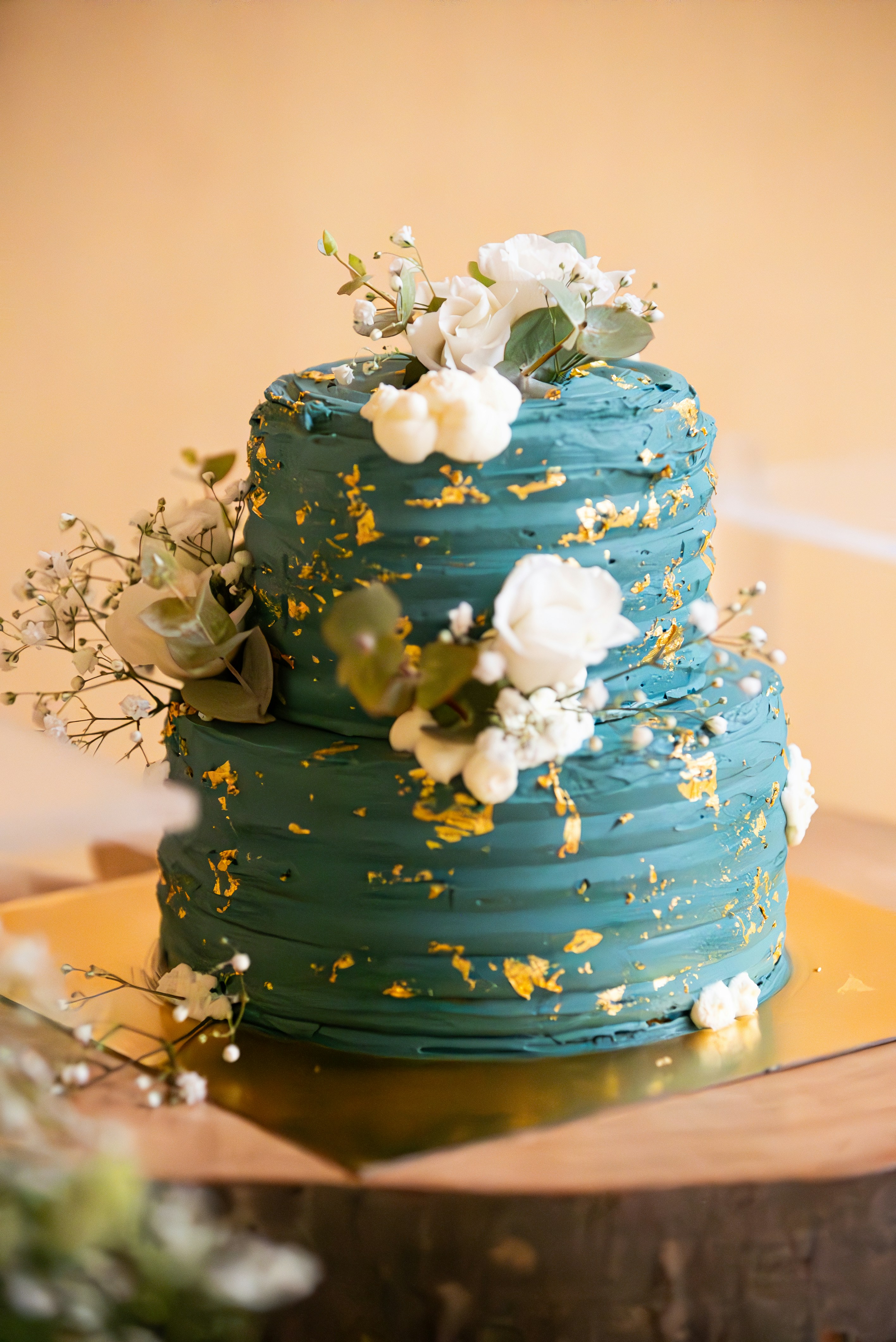 A three tiered blue cake with white flowers on top photo – Free Flower ...