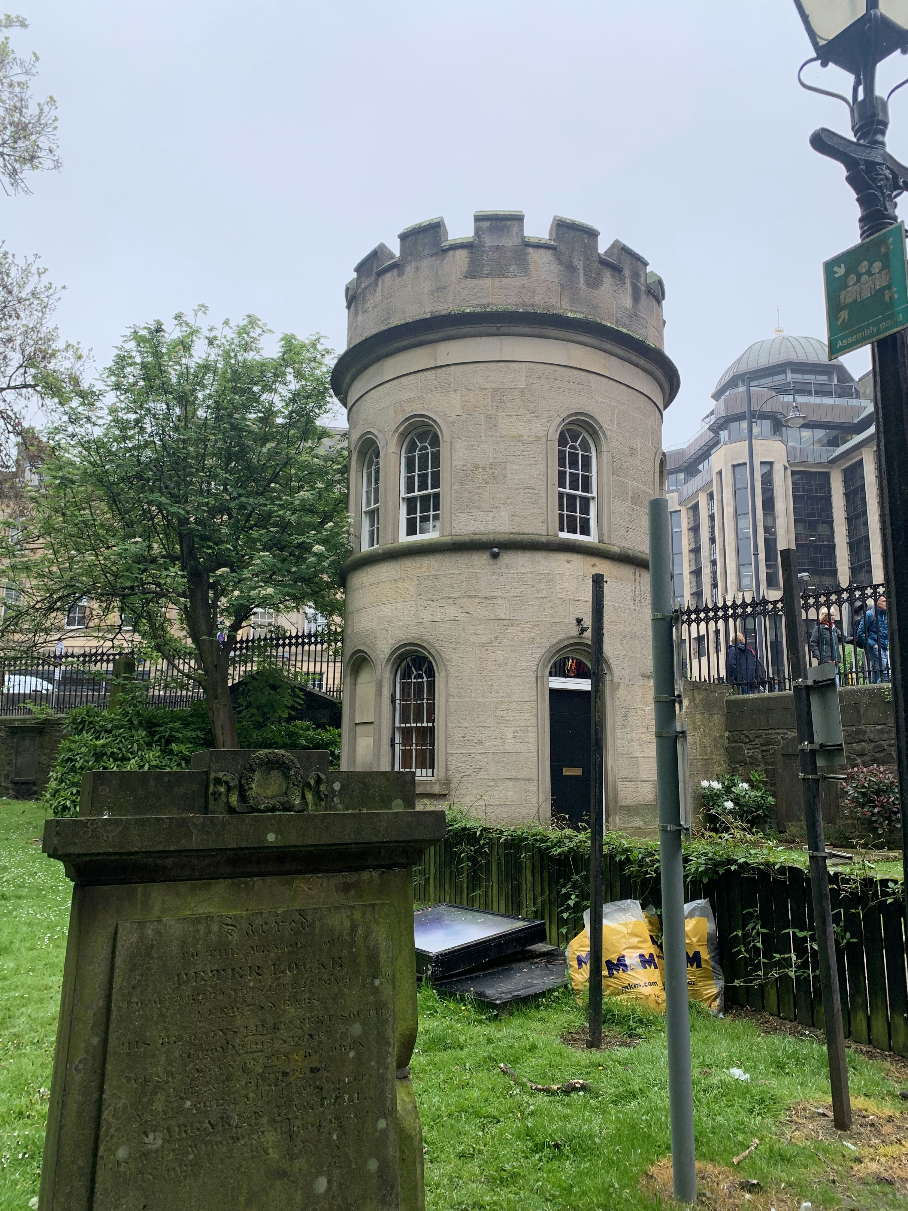 A Tiny Turreted Structure Standing Guard Over a Lush City Corner