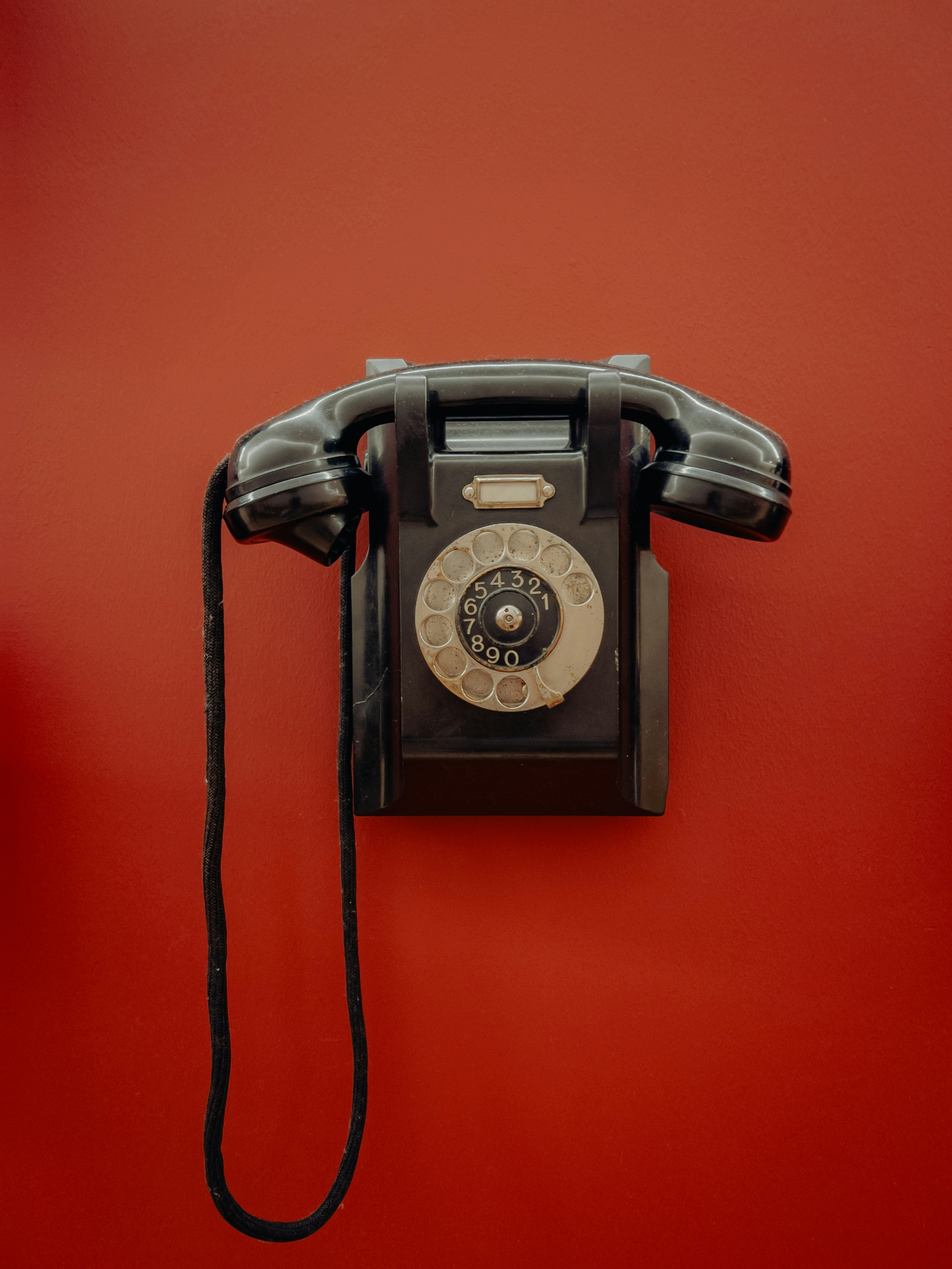An old fashioned telephone on a red wall photo – Free Phone Image on ...