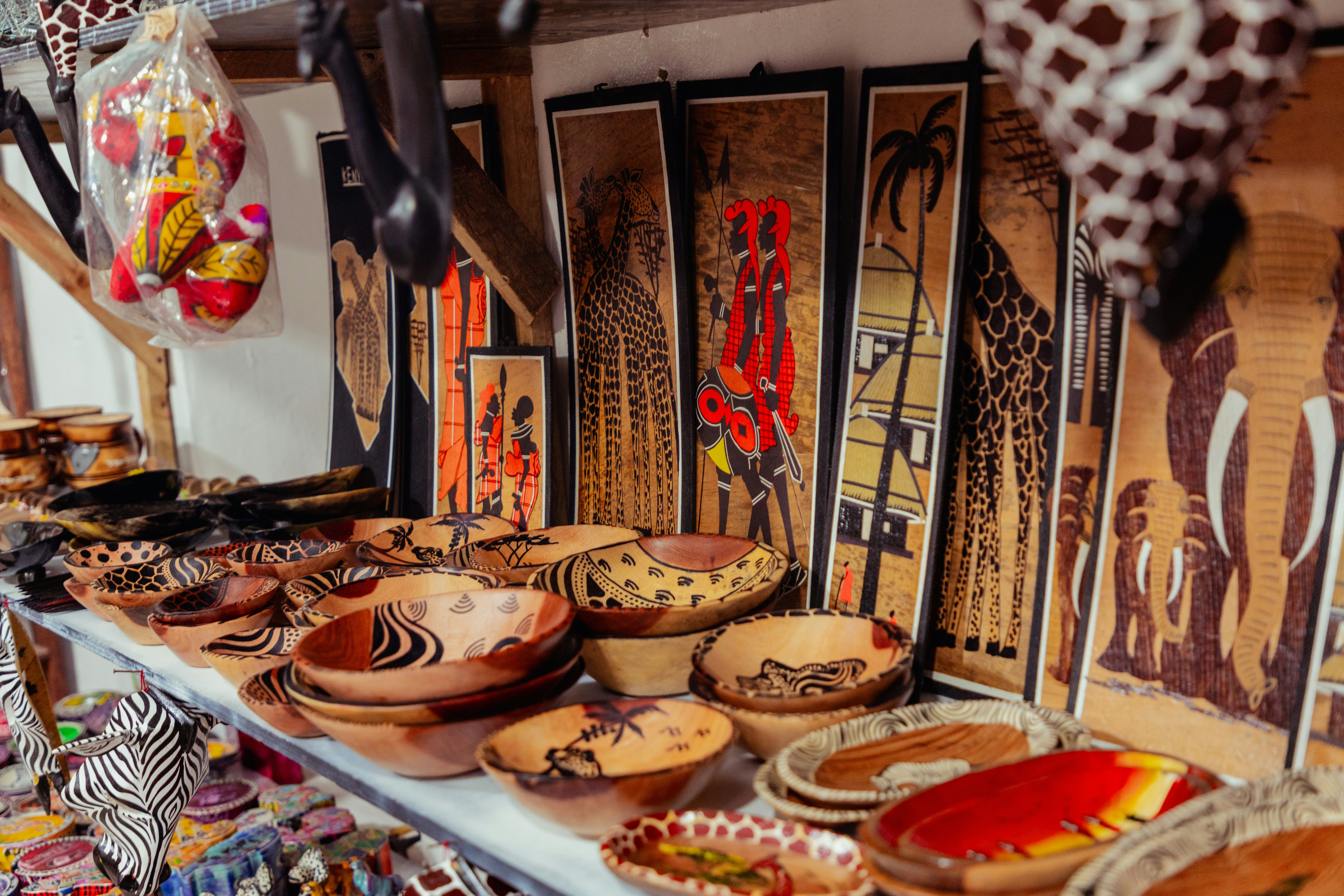Hand-Carved Bowls and Painted Panels in a Colorful Market Stall