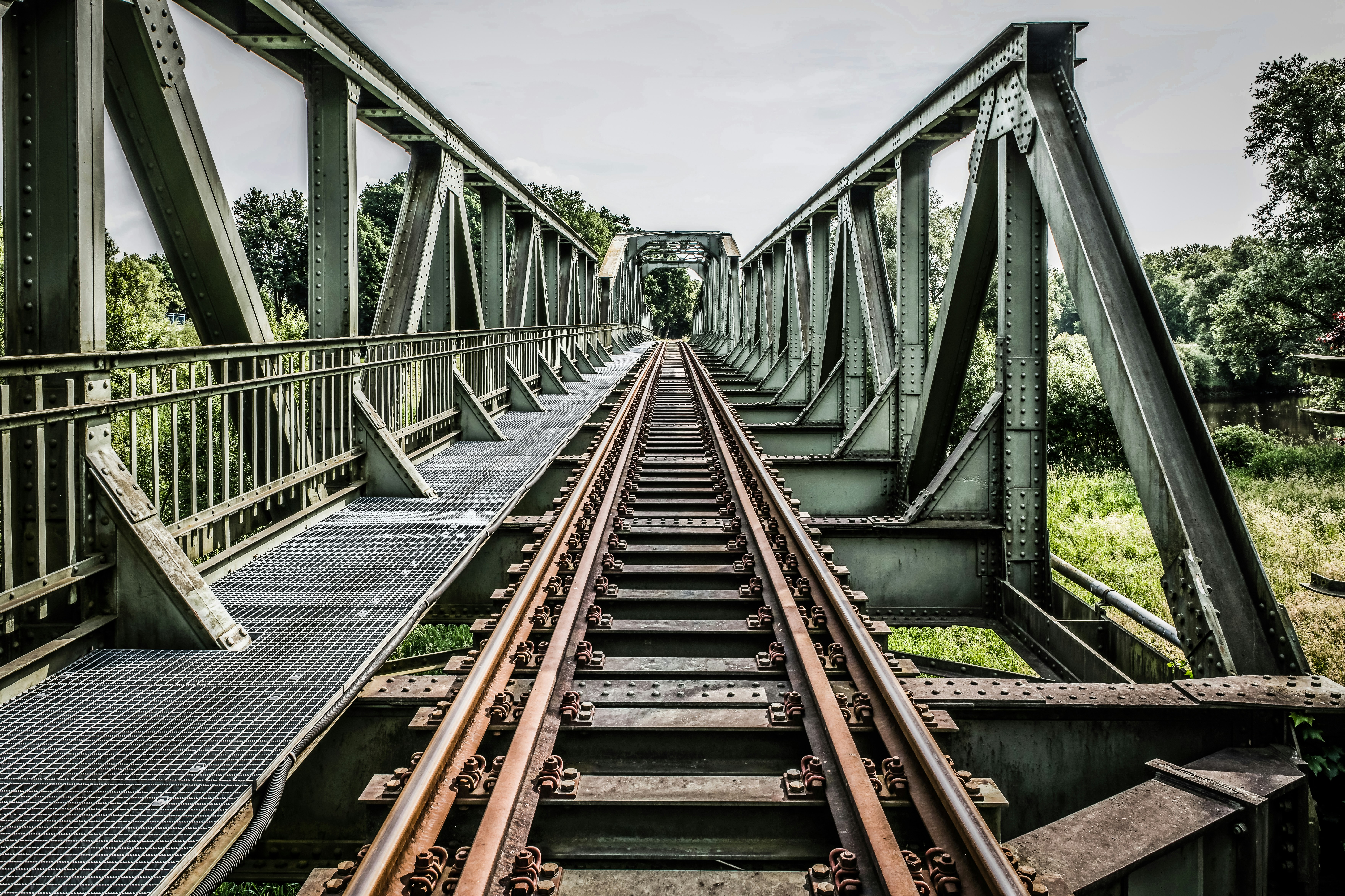 A train track going across a bridge over water photo – Free Winsen ...