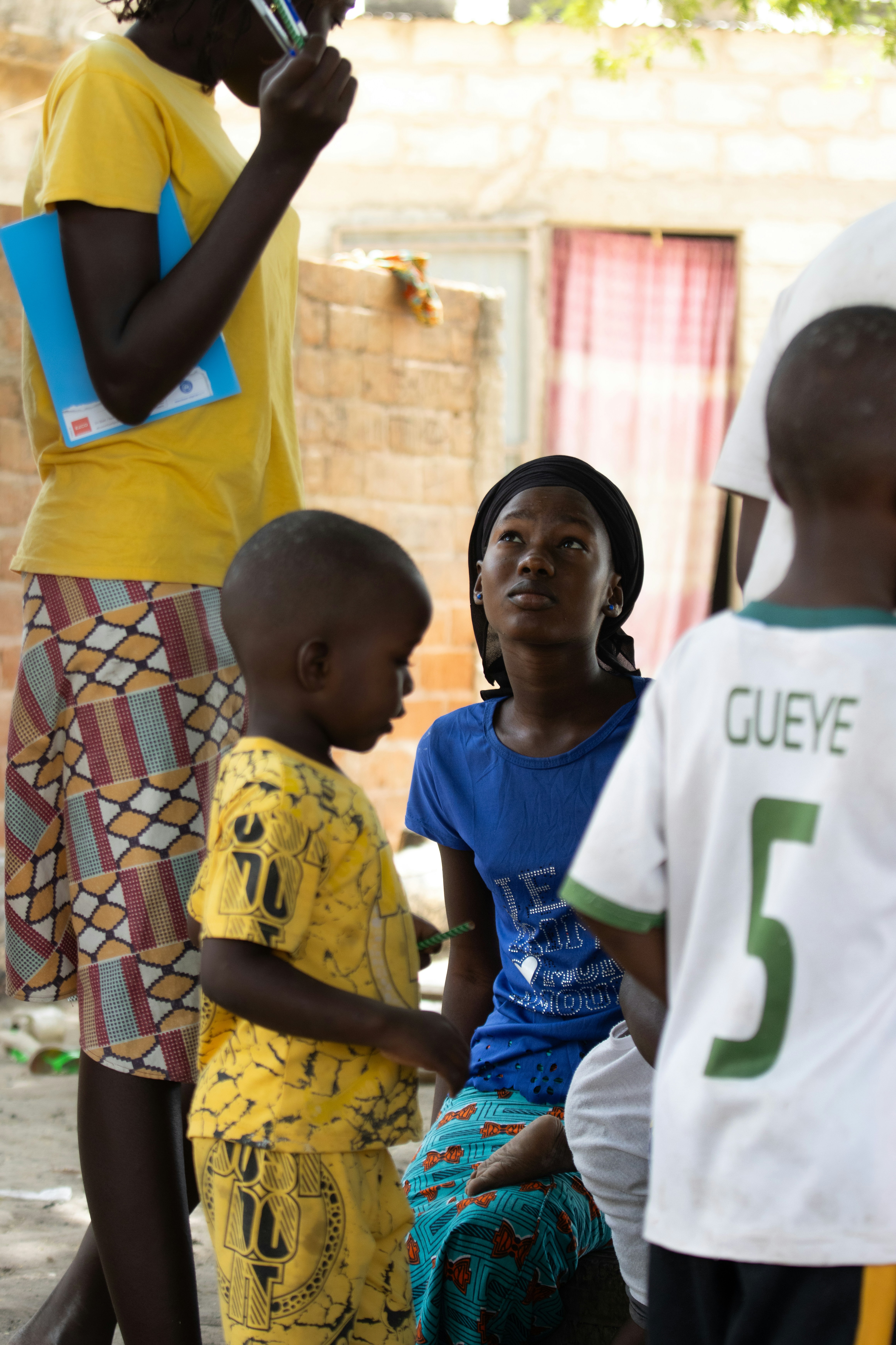 A group of children standing around each other photo – Free Portrait ...