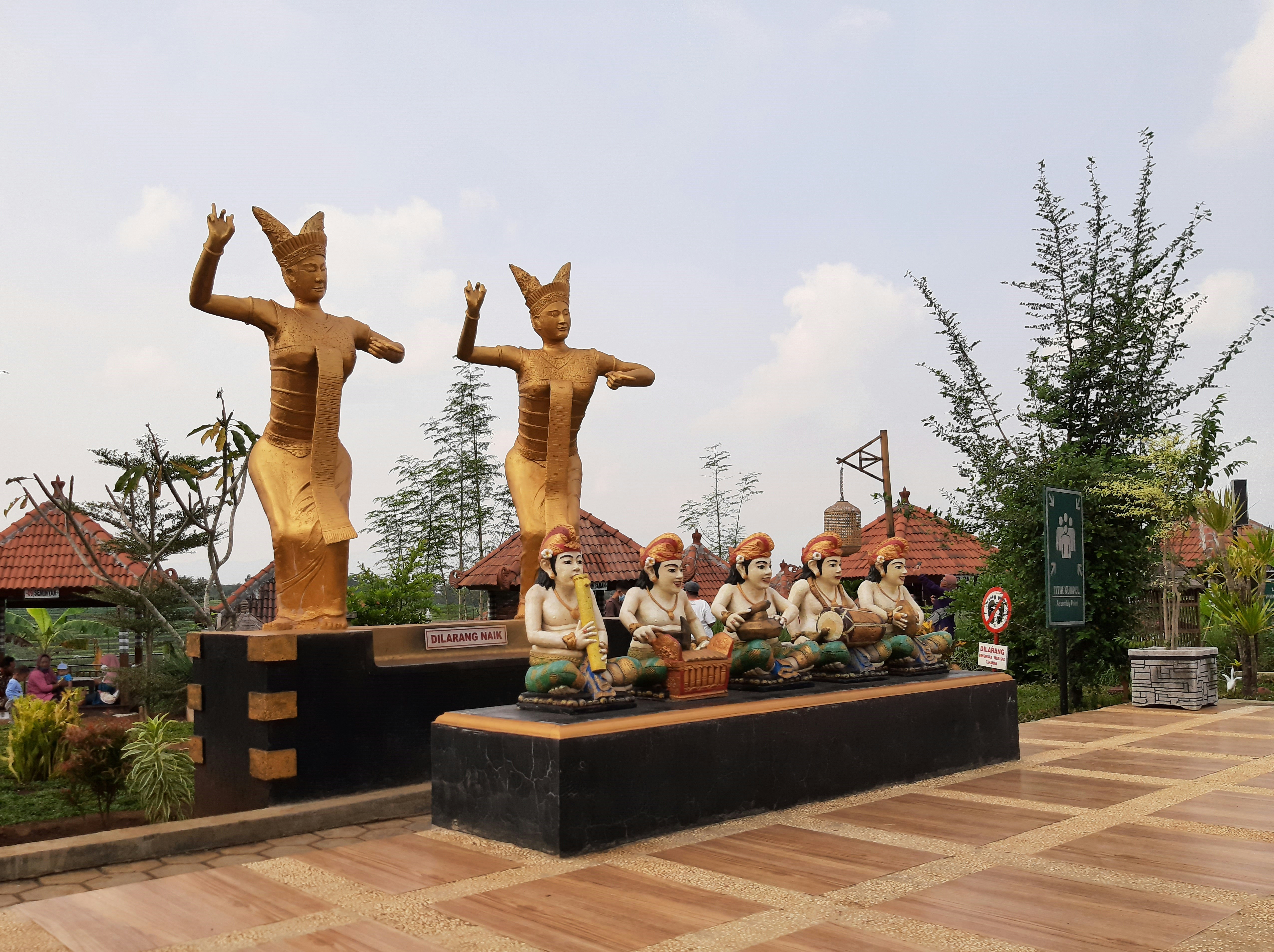 A group of statues sitting on top of a wooden platform photo – Free Art ...