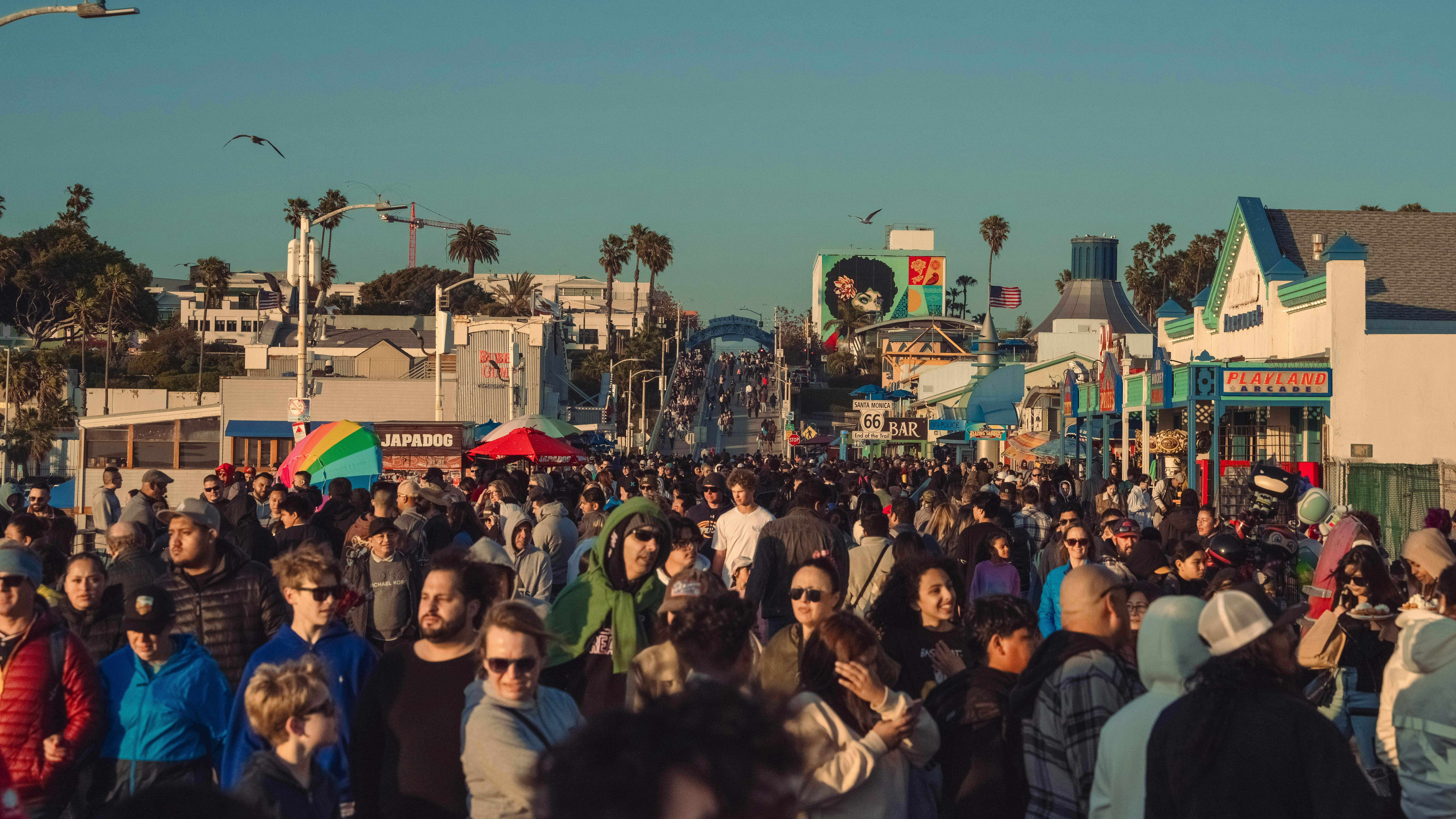 A large crowd of people walking down a street photo – Free Santa monica ...