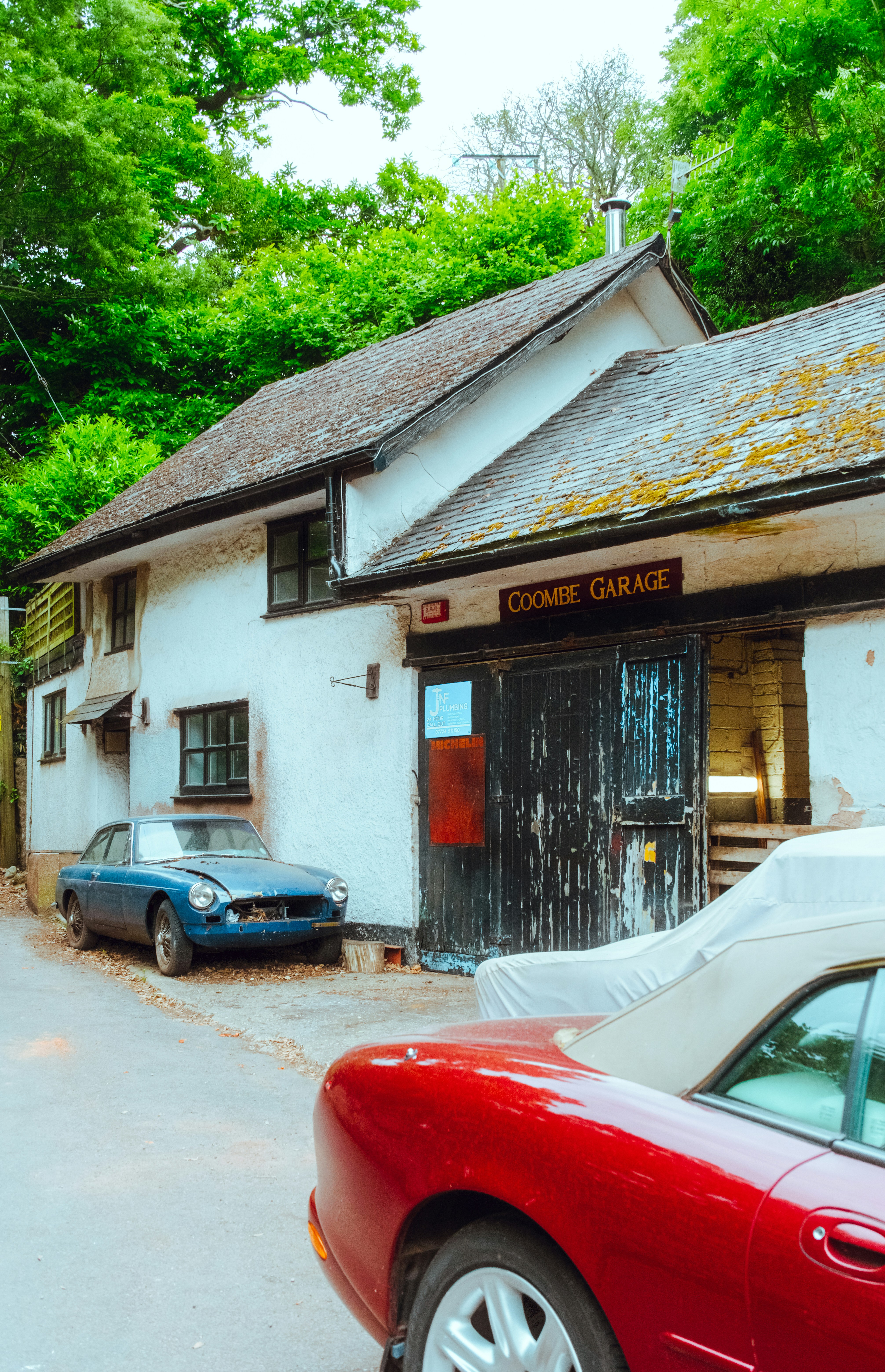 Cottage Garage Blues: A Weathered Facade and Painted Reds