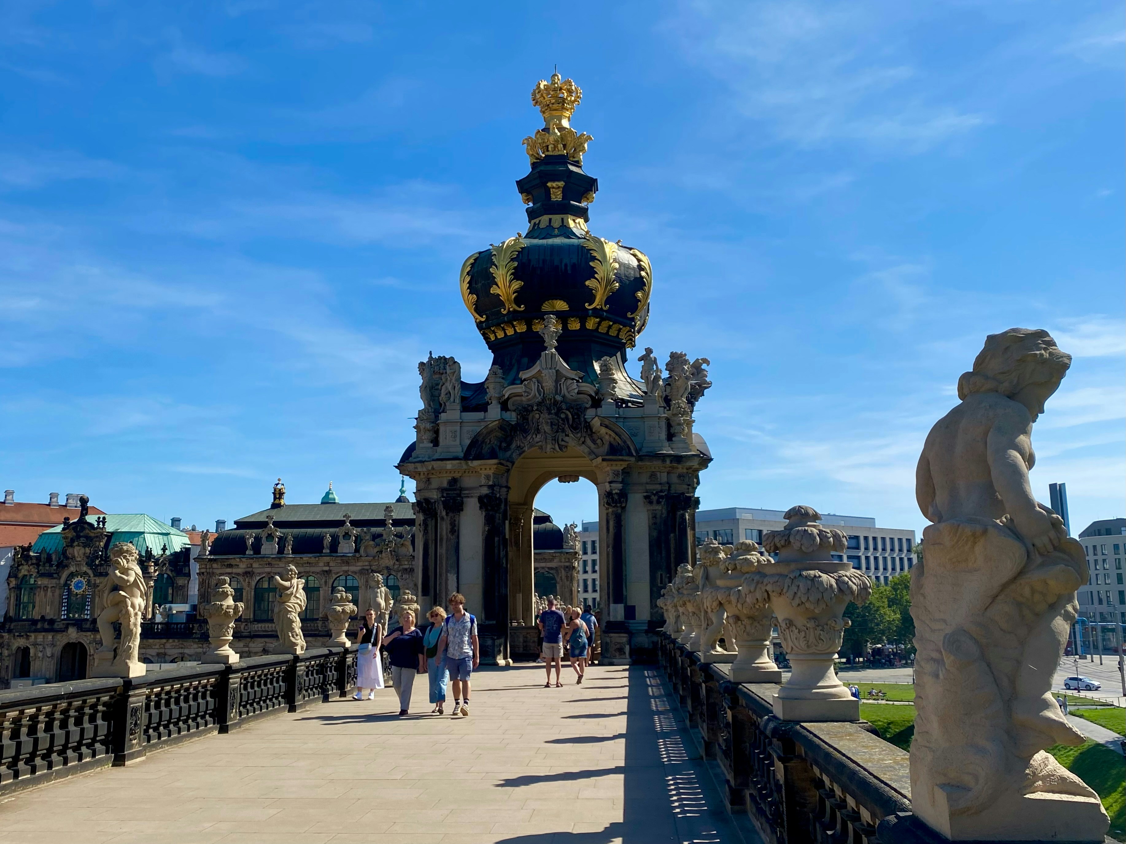 A bridge with statues and a clock tower in the background photo – Free ...
