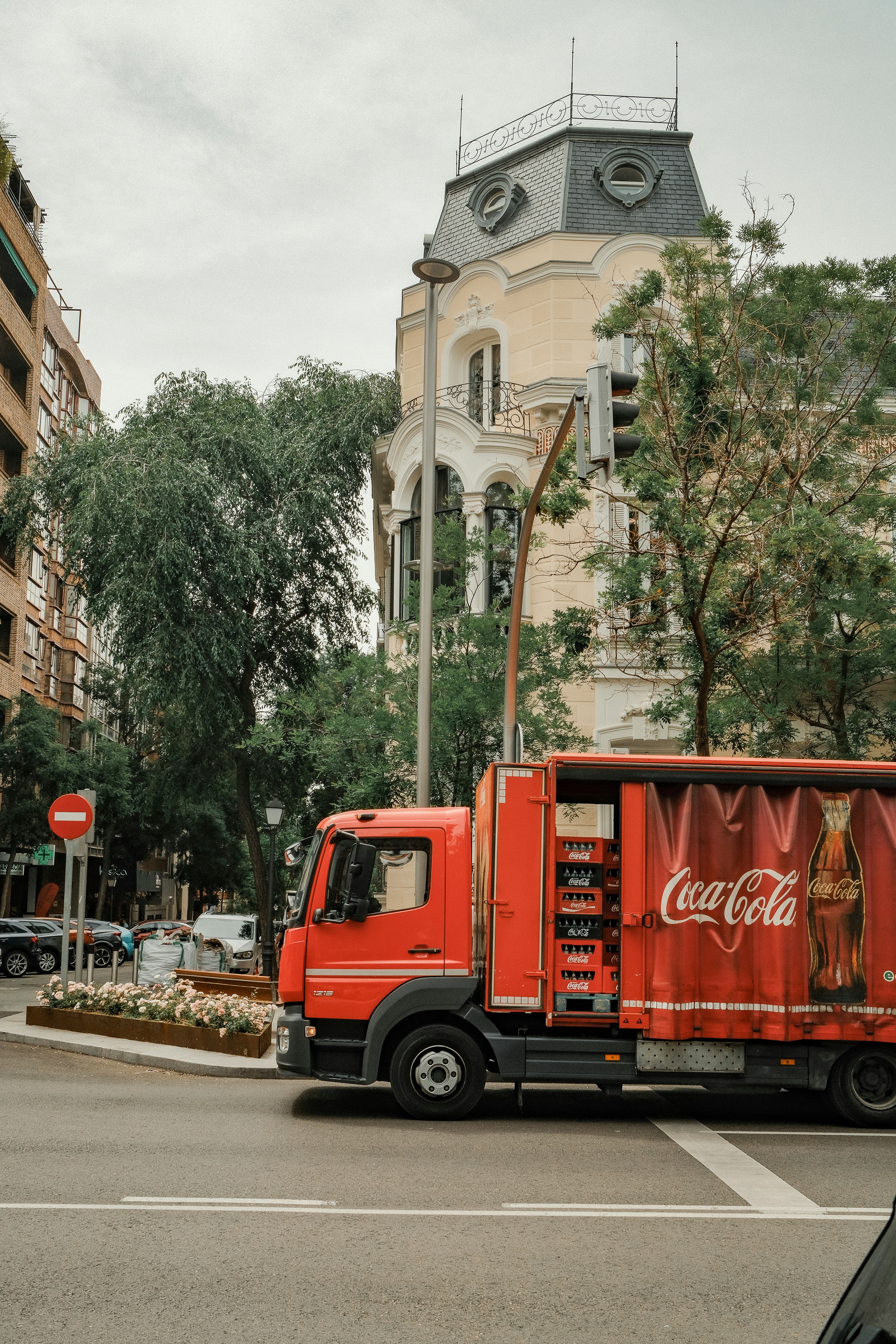 Crimson Coca-Cola Truck at a Quiet Urban Crossing
