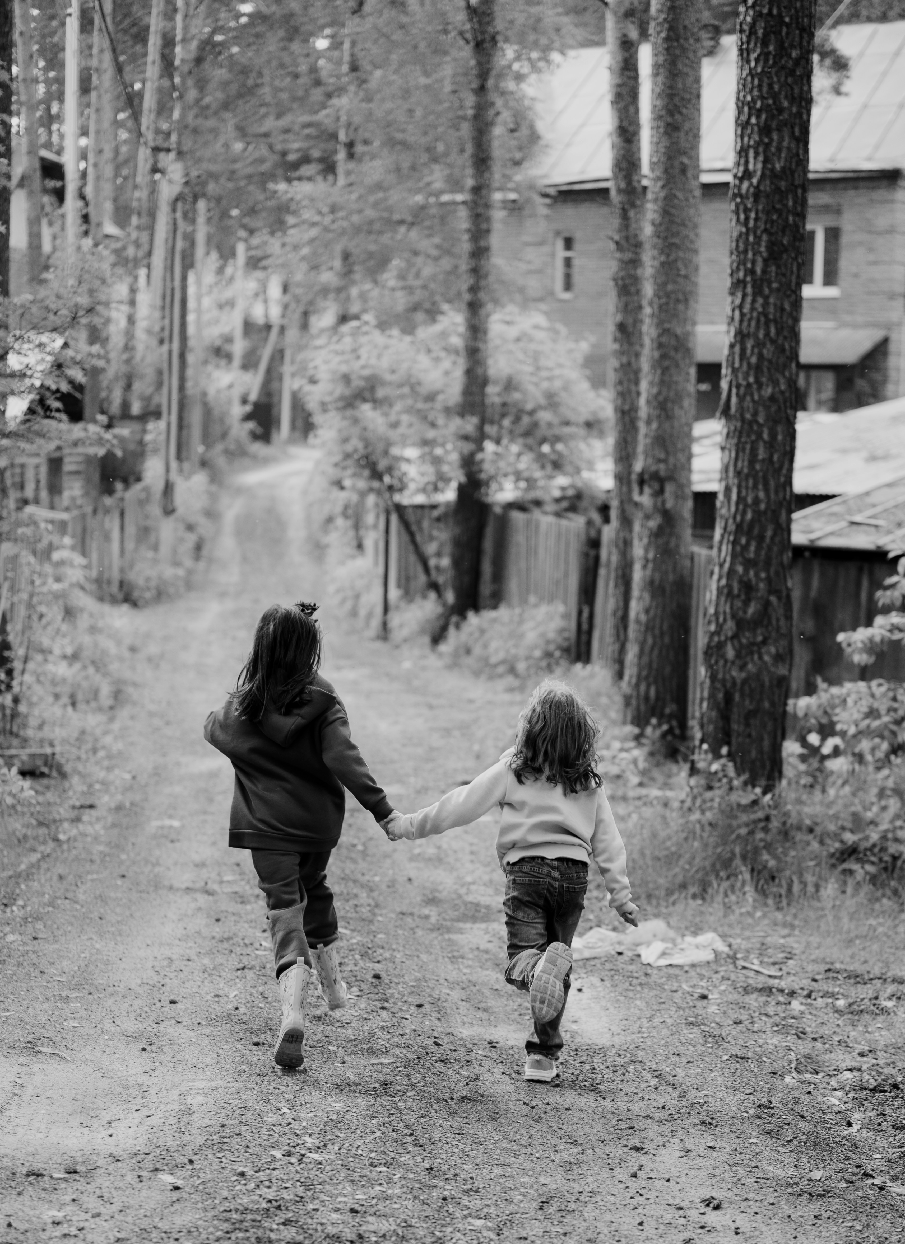 Two children running down a dirt road holding hands photo – Free Child ...