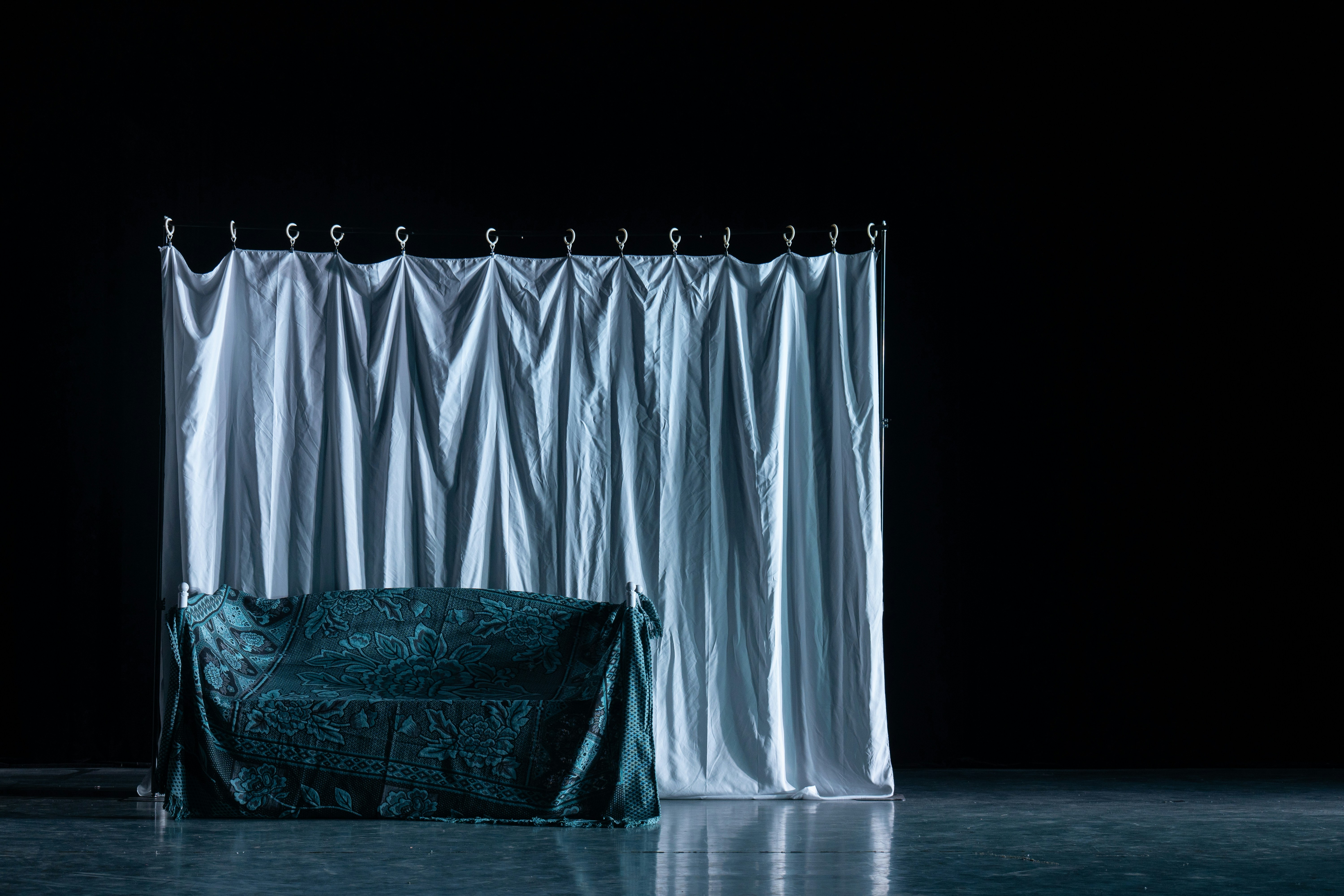 Midnight Illusion Behind White Drapes: A Quiet Stage with a Draped Tablecloth
