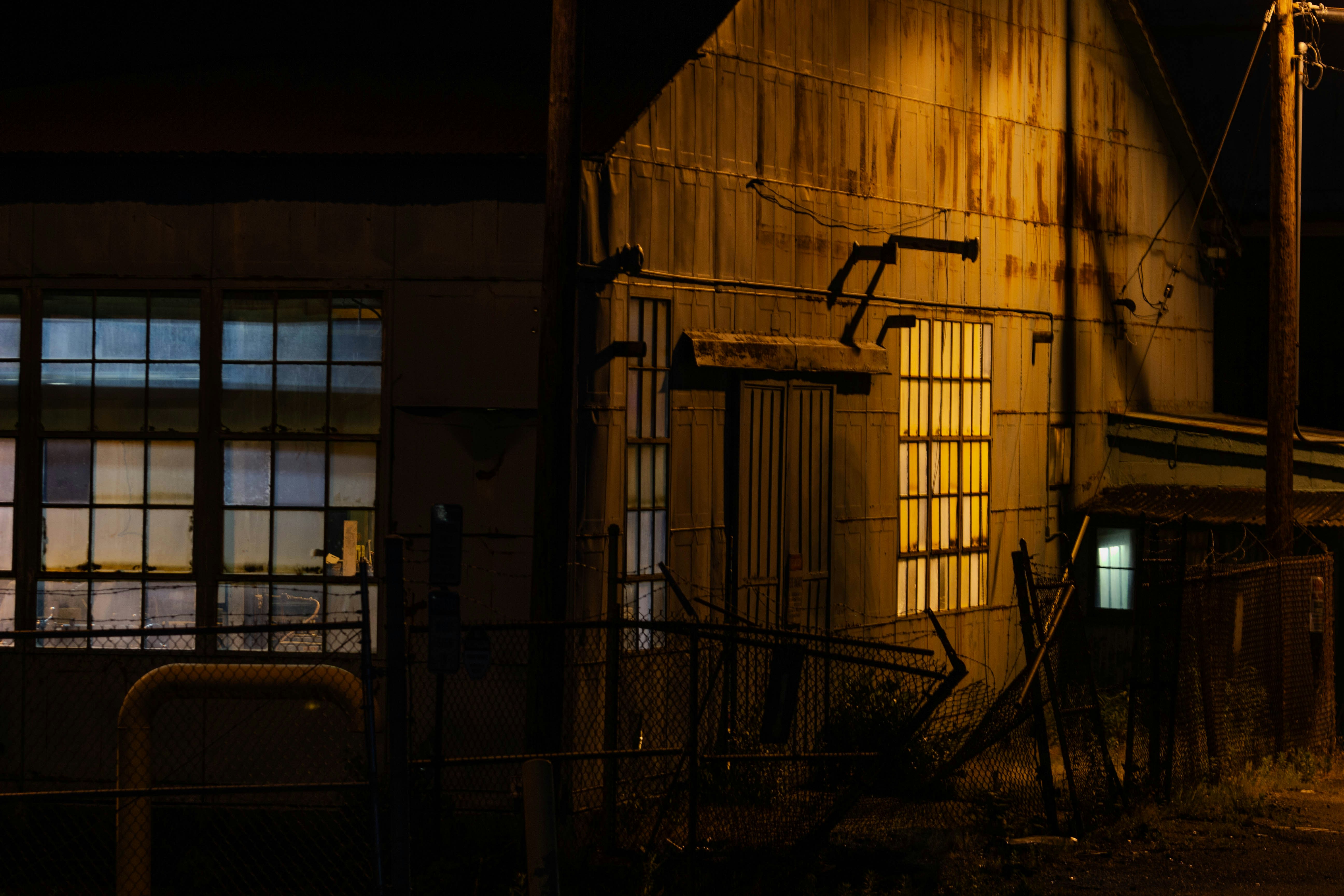 A building that has a bunch of windows in it photo – Free Night Image ...