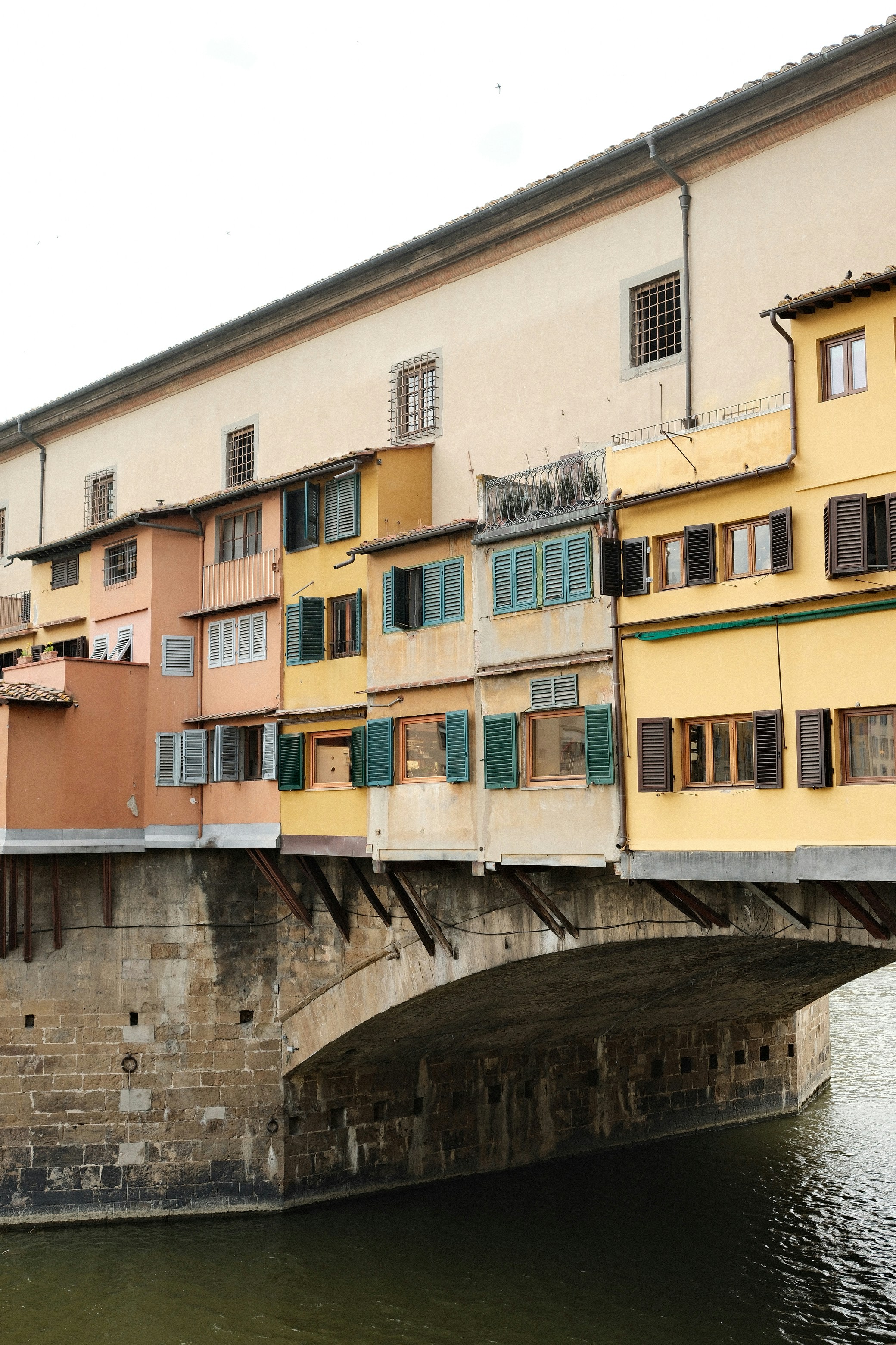 Pastel Facades on a Stone-Arch Bridge Over the River