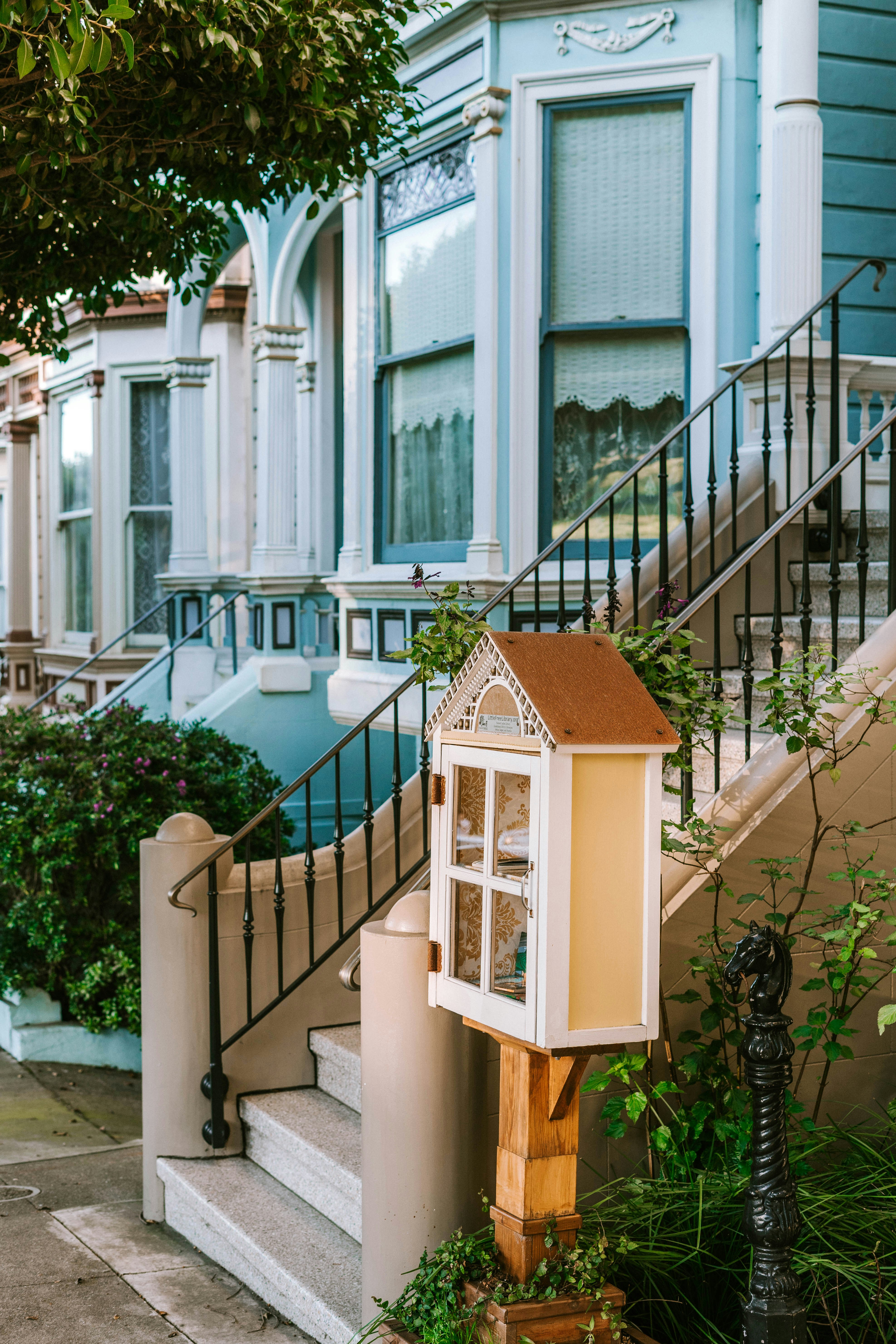 A bird house sitting on the steps of a house photo – Free Bay window ...