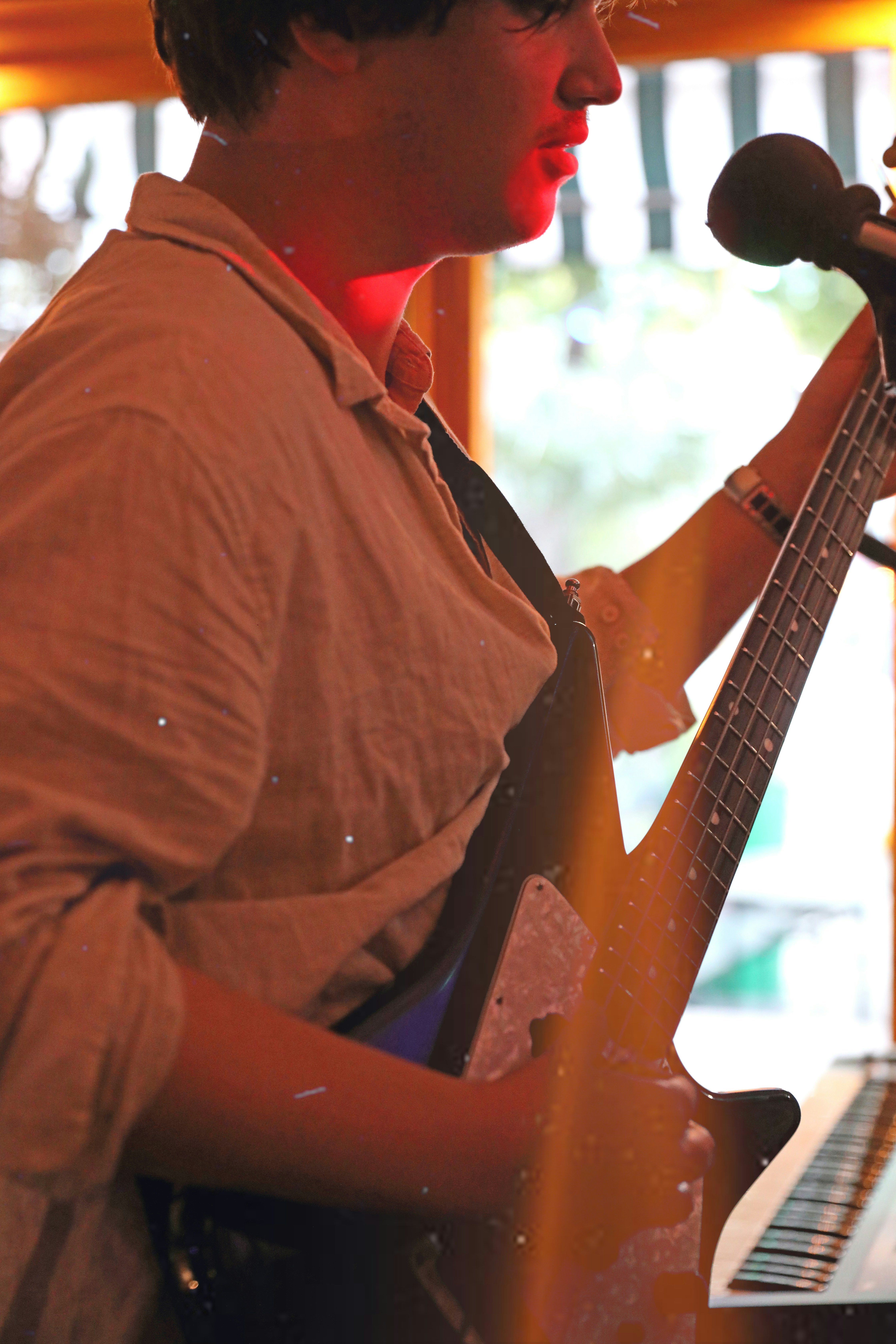 A man playing a musical instrument in front of a microphone photo ...