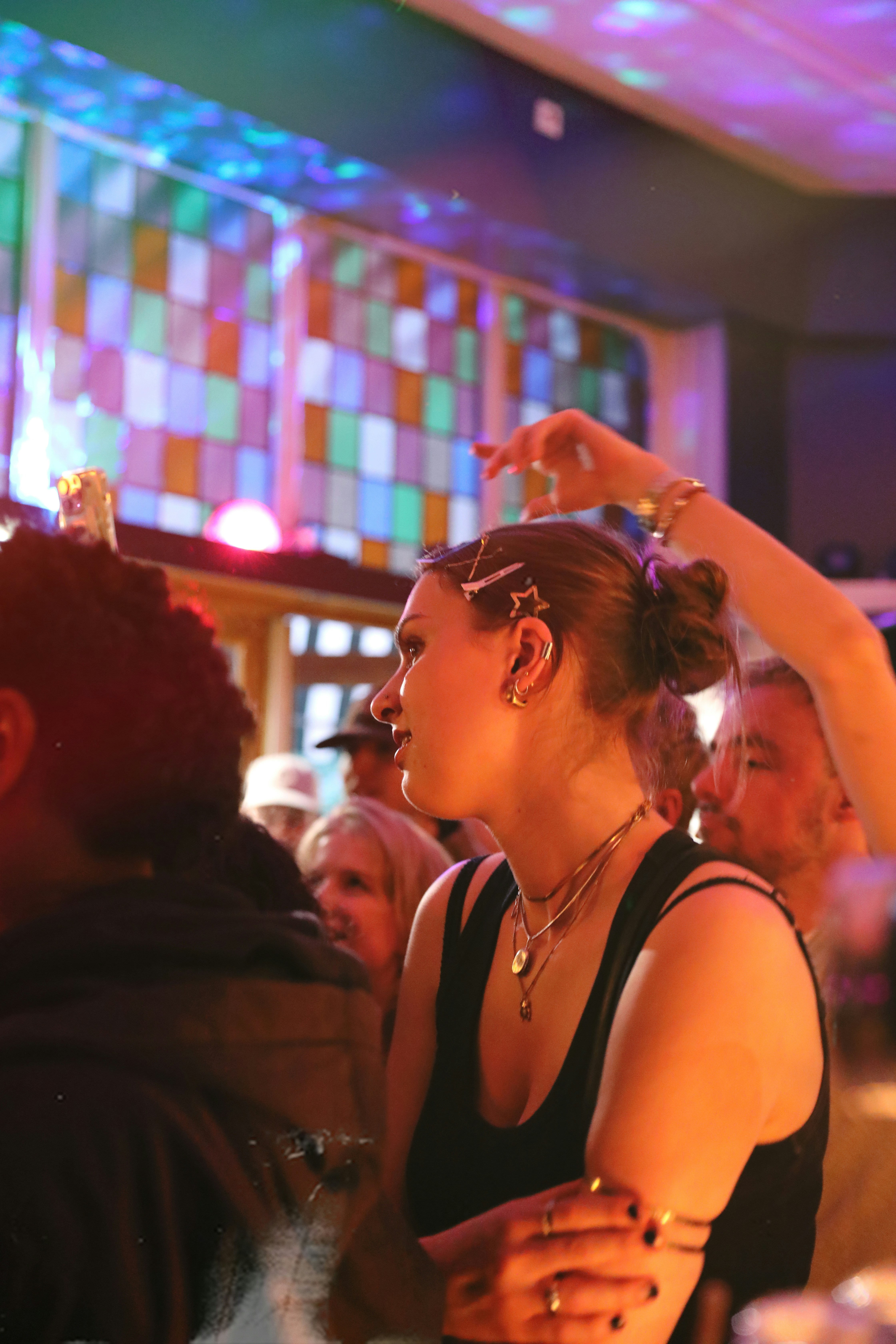A woman in a black tank top is dancing photo – Free Fans Image on Unsplash