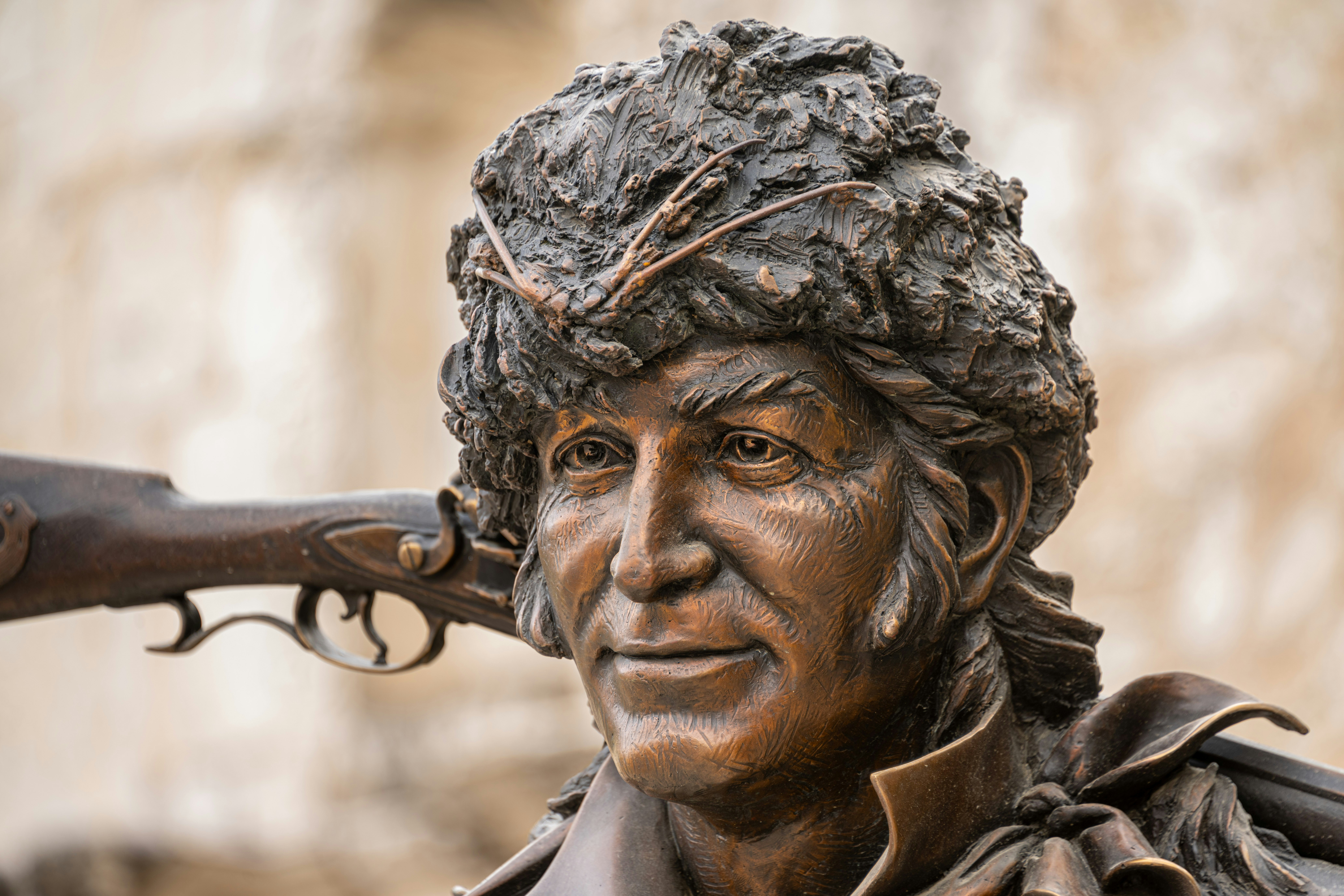 A bronze statue of a man with a gun photo – Free Gun Image on Unsplash