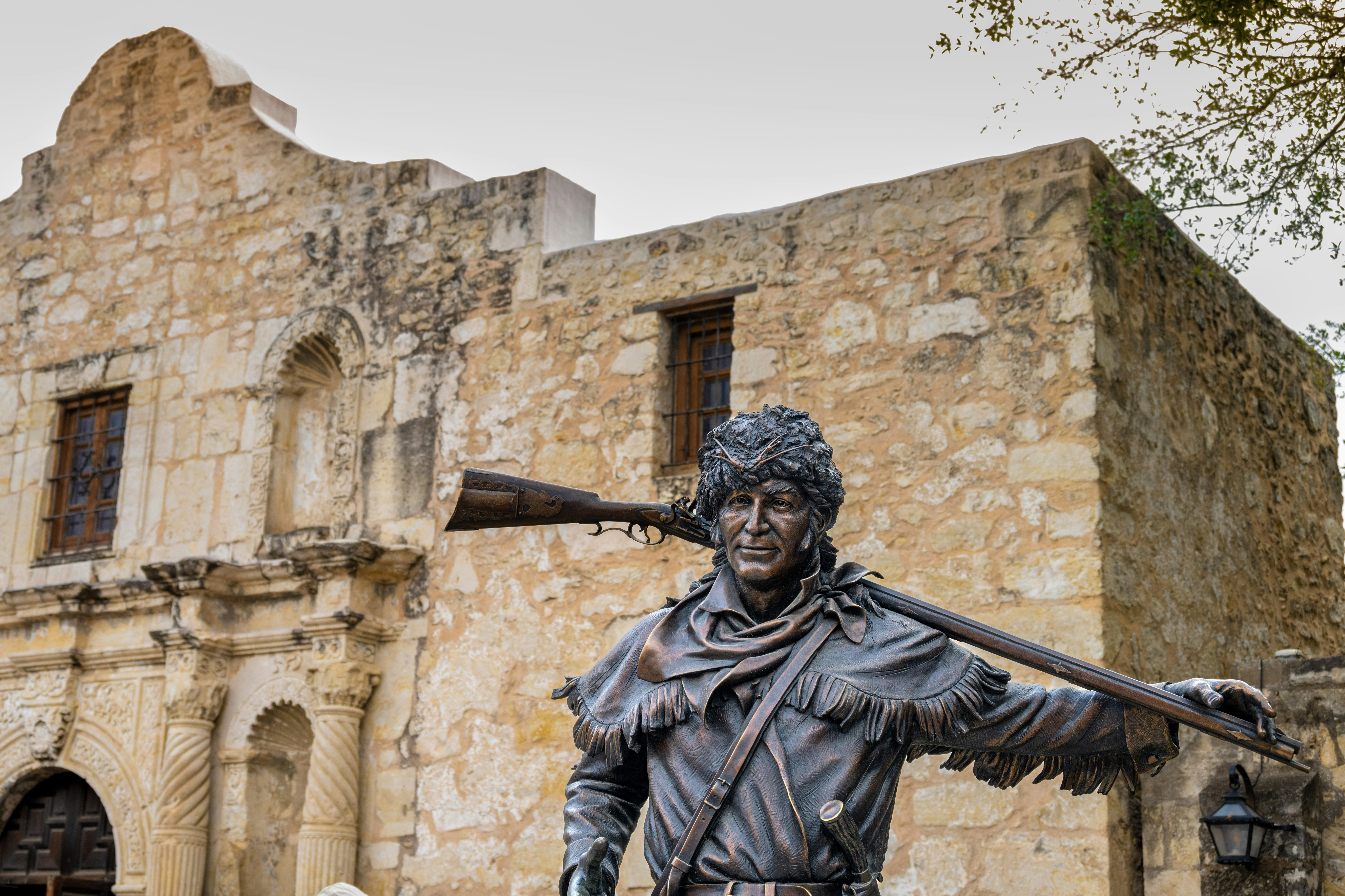 Bronze Rifleman Framed by a Crumbling Stone Facade