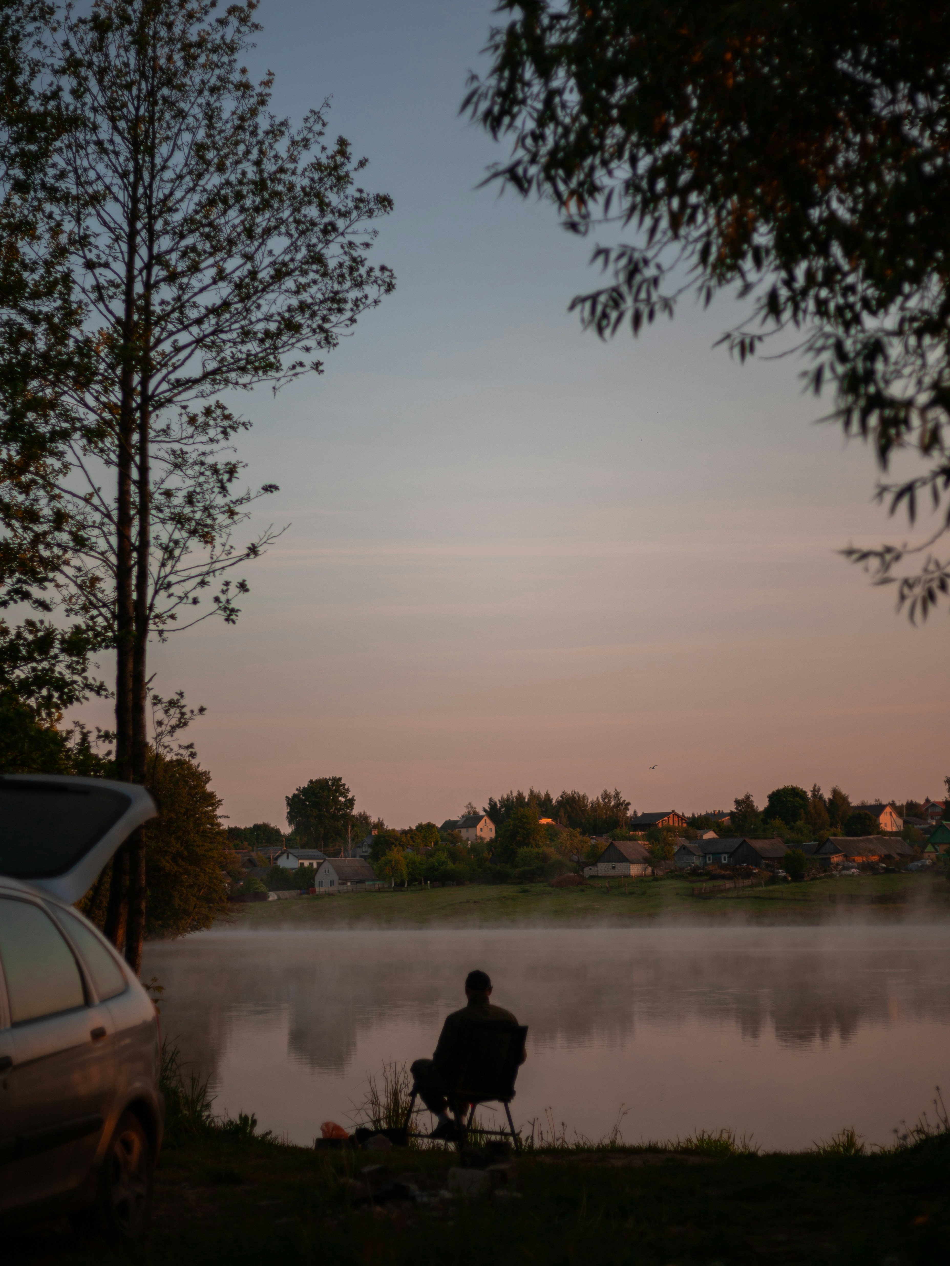 Evening by the Mist-Lit Lake: Angler at the Quiet Shore