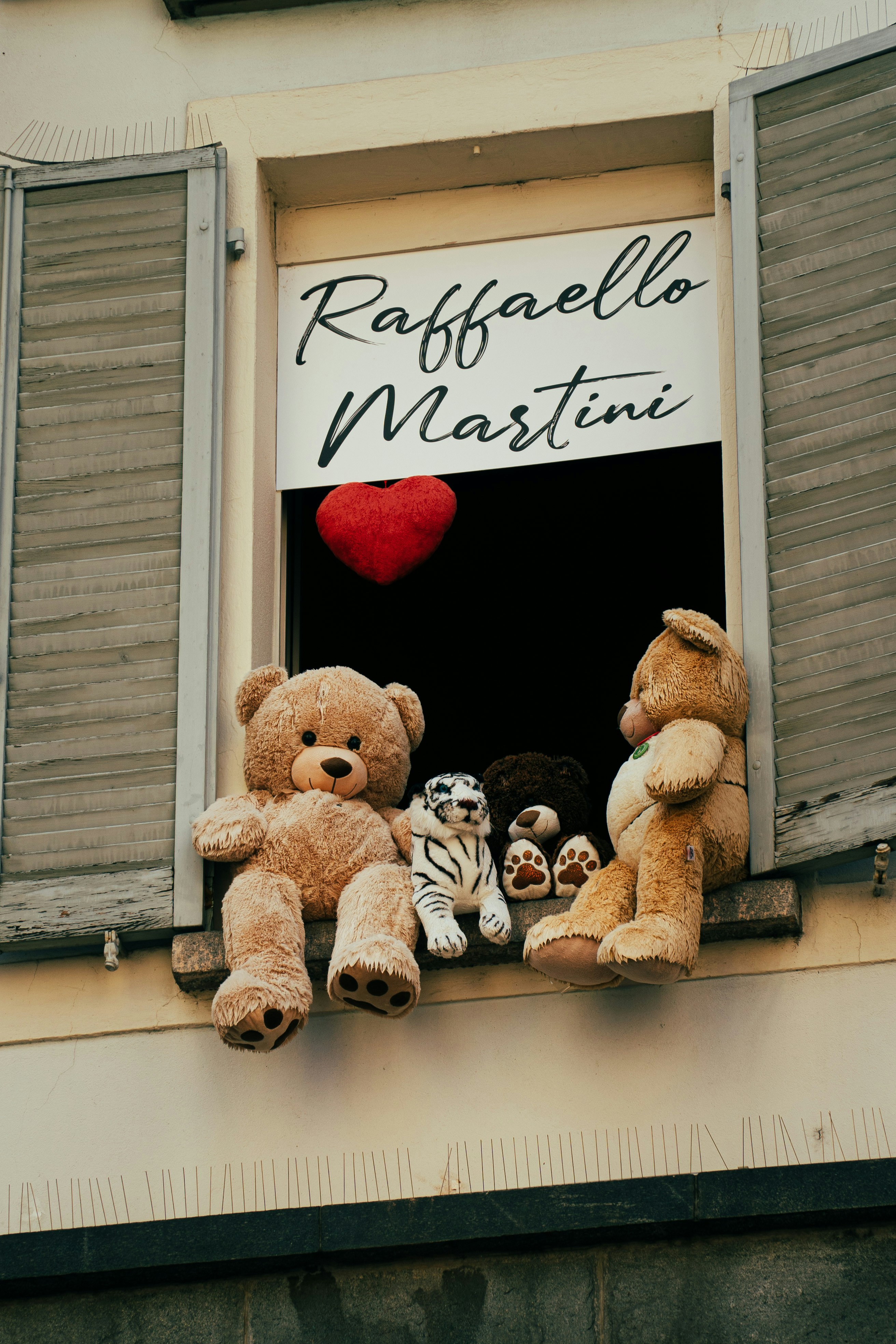 A group of stuffed animals sitting on a window sill photo – Free Travel ...