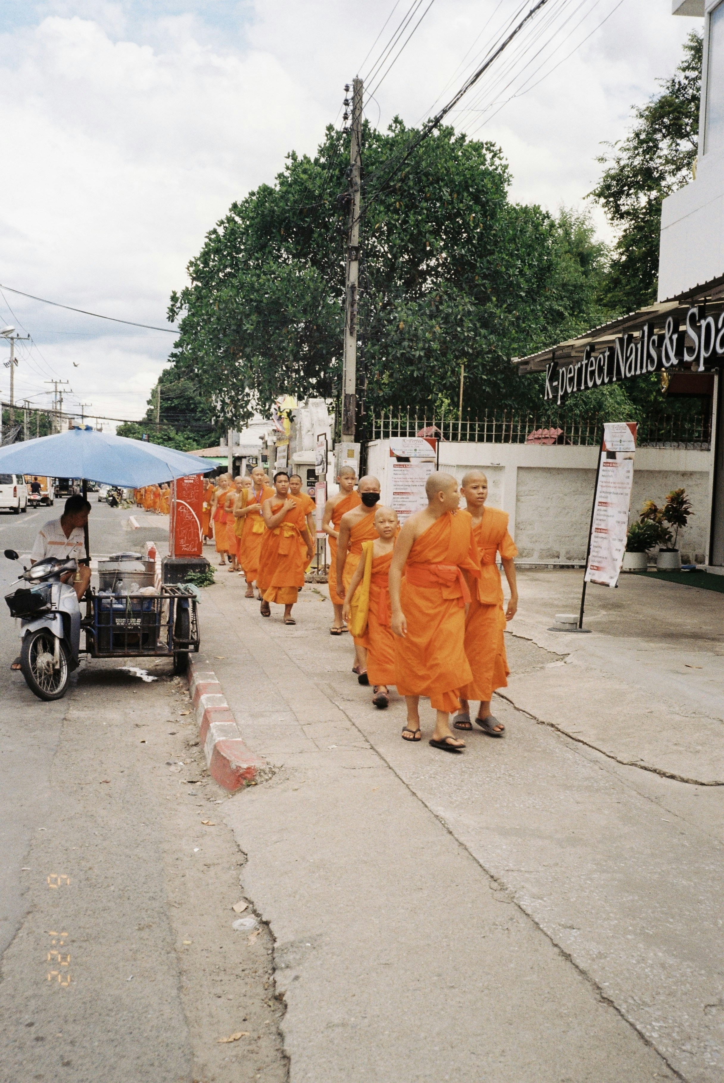 Saffron Parade: Monks Quietly Move Through a City Street