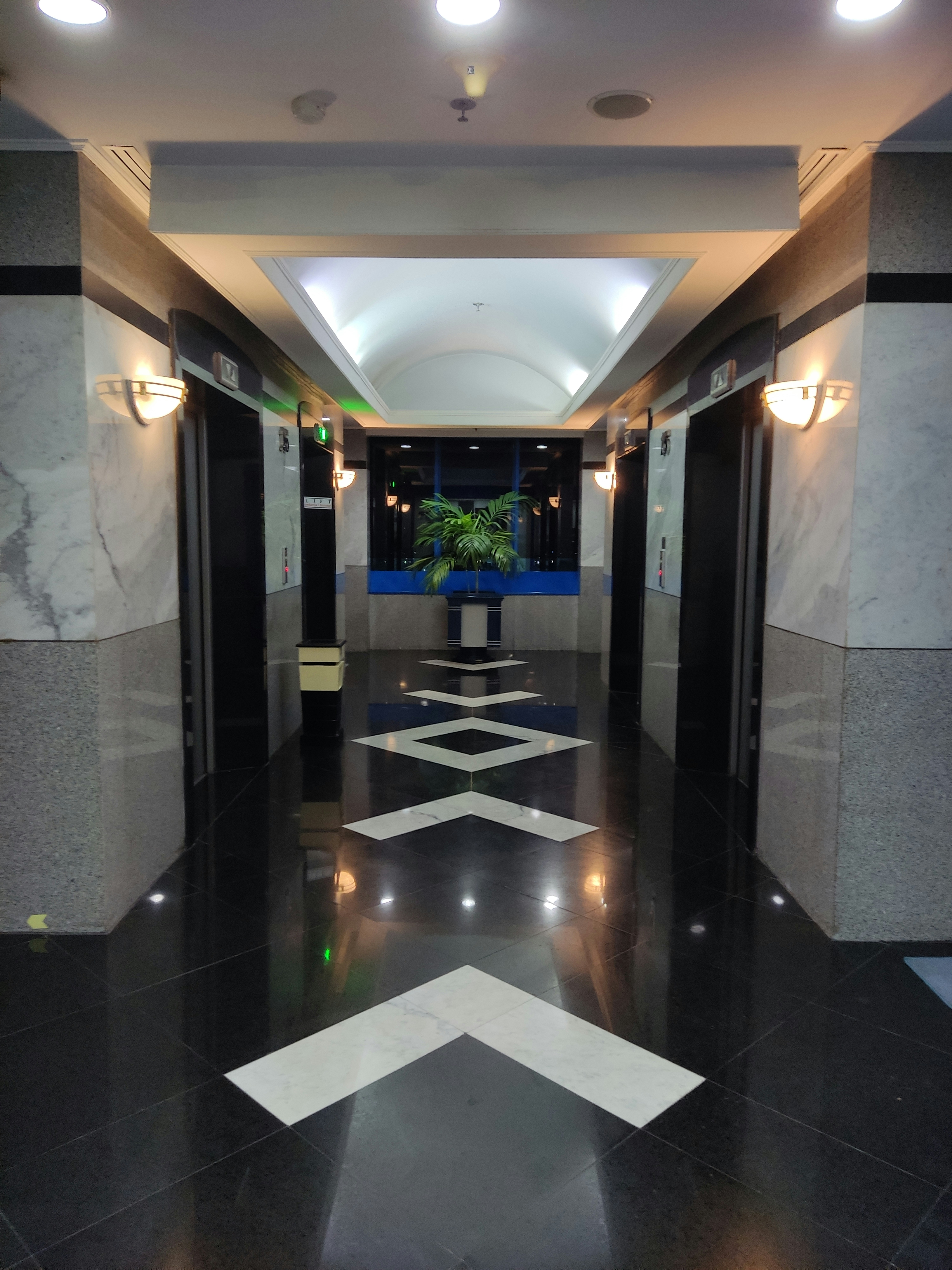 A long hallway with a white arrow painted on the floor photo – Free ...