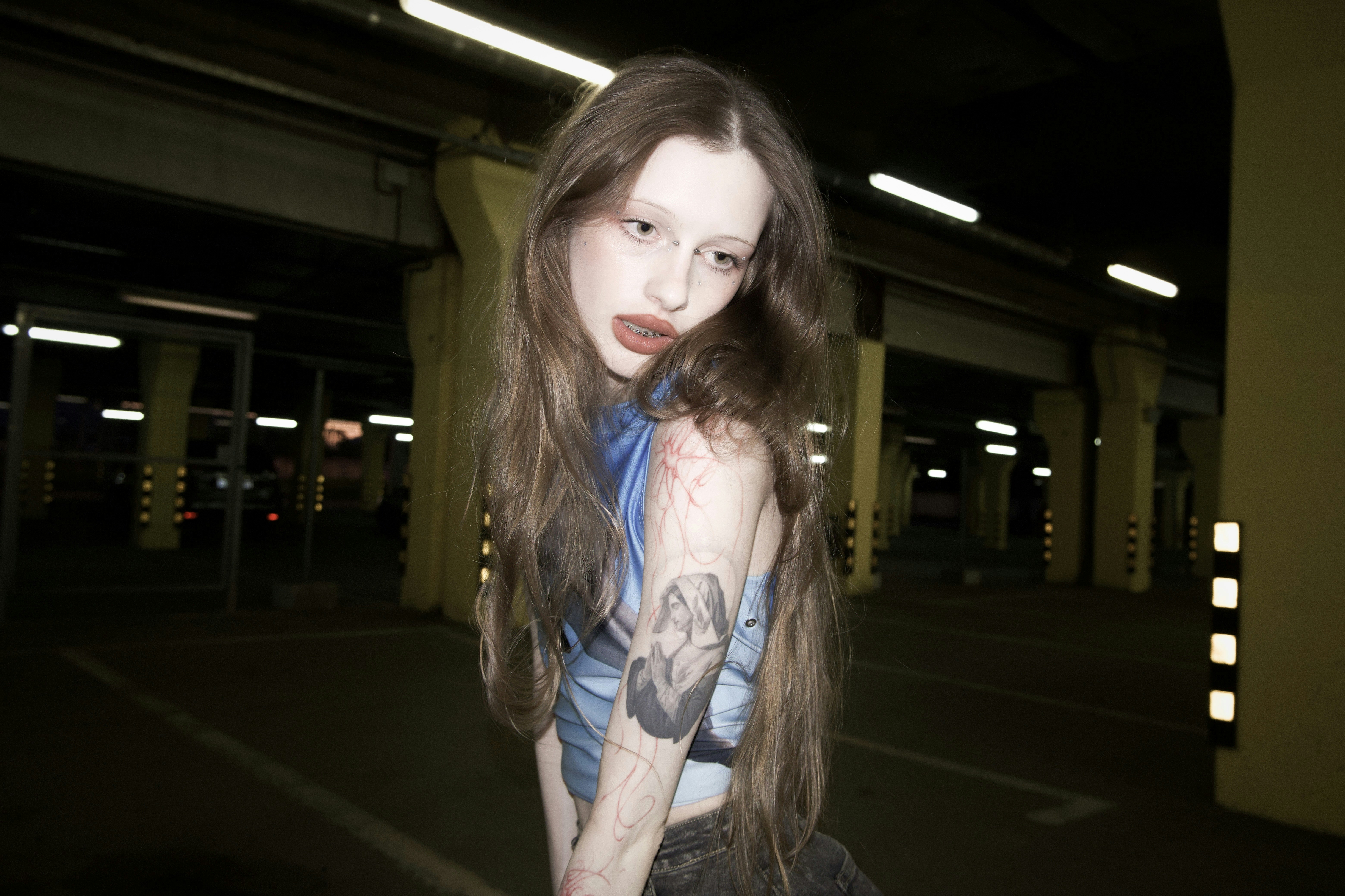 Electric Moonlight: Portrait of a Tattooed Youth in a Neon Parking Garage