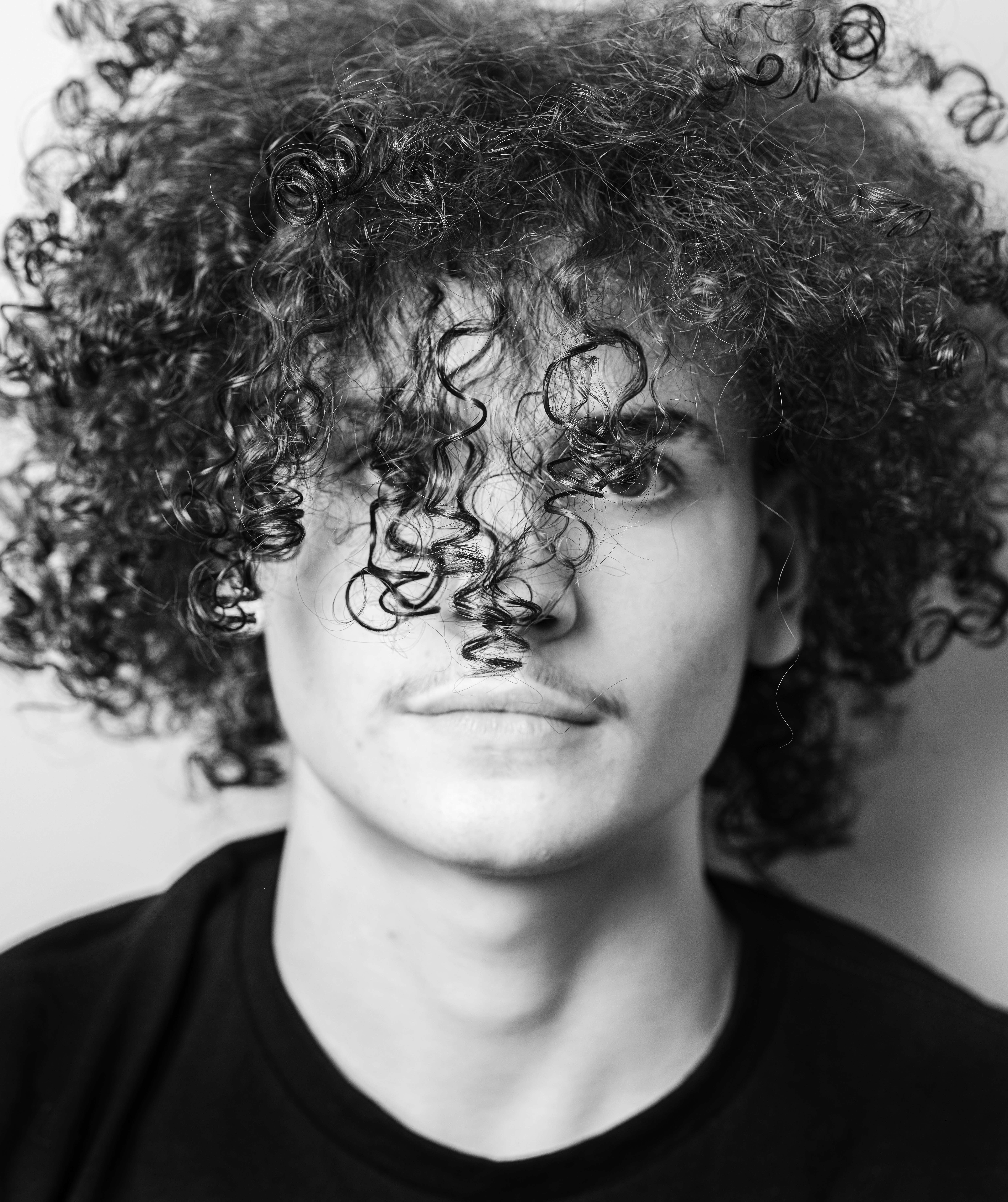 Direct Gaze Through Cascading Curls: A Mono Portrait Study