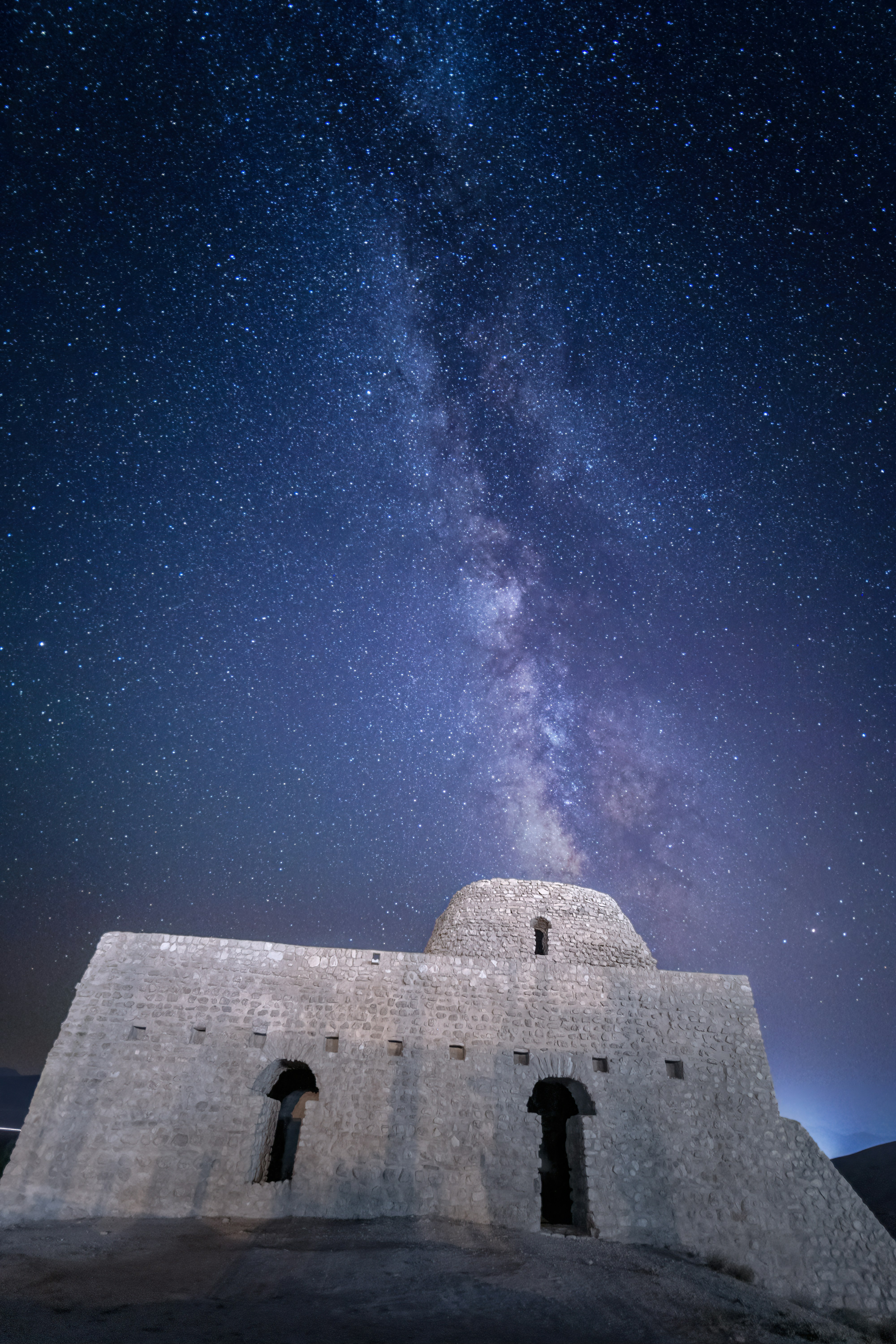 A building under a night sky filled with stars photo – Free Night Image ...