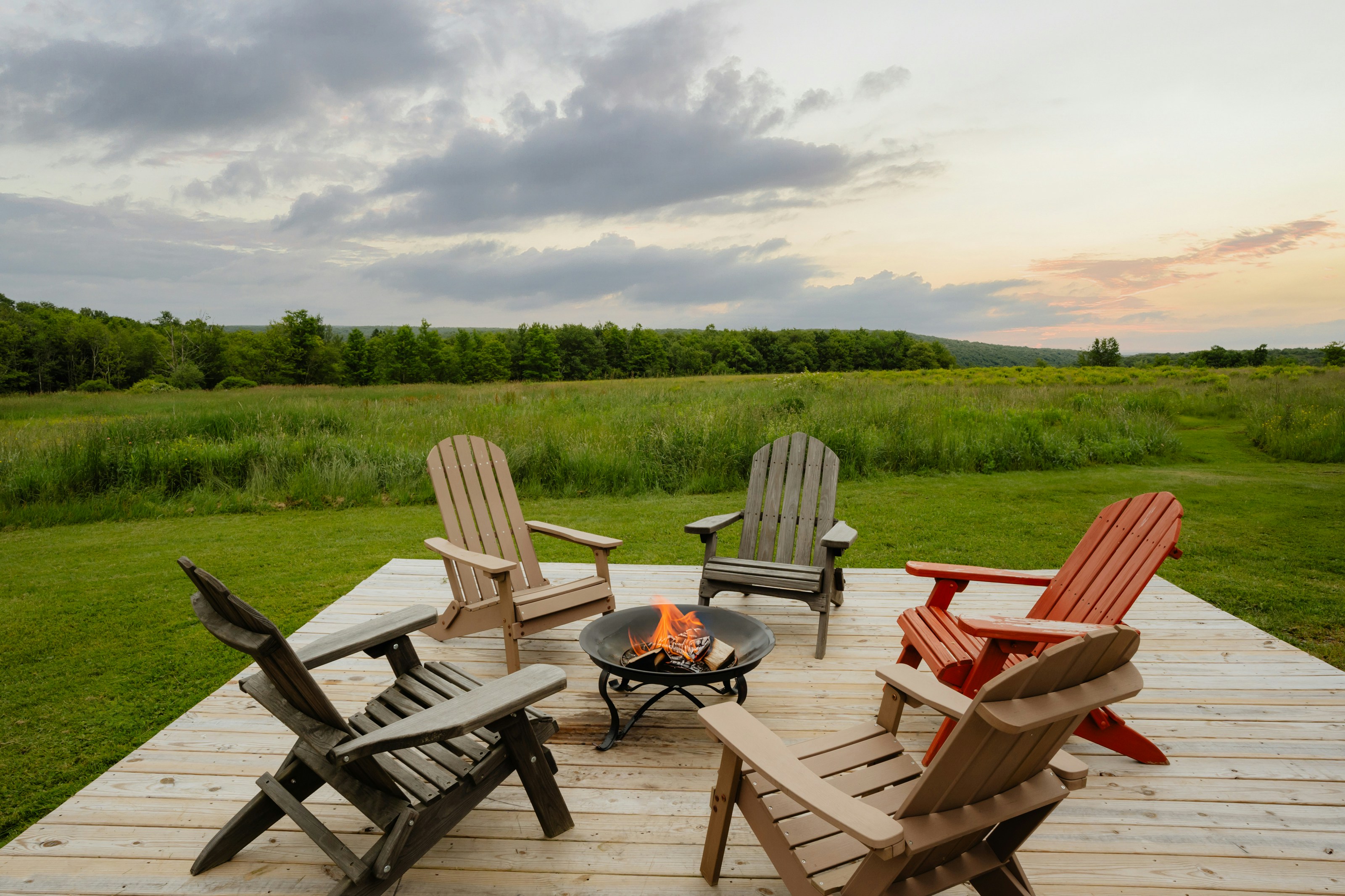 A group of chairs sitting on top of a wooden deck photo – Free ...