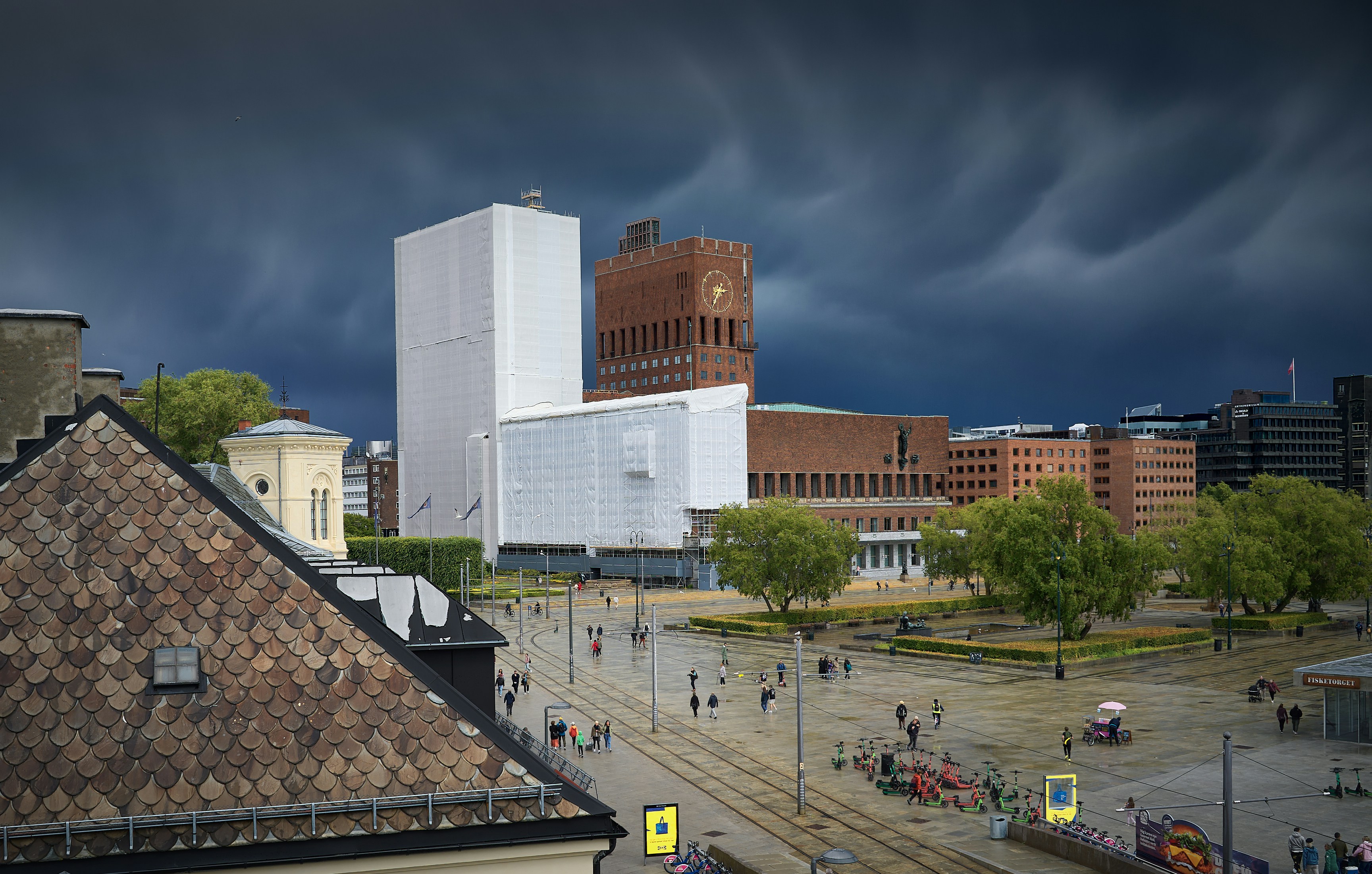 White Prism Above a Brick Clock Tower: Where Modern Meets History in a City Square