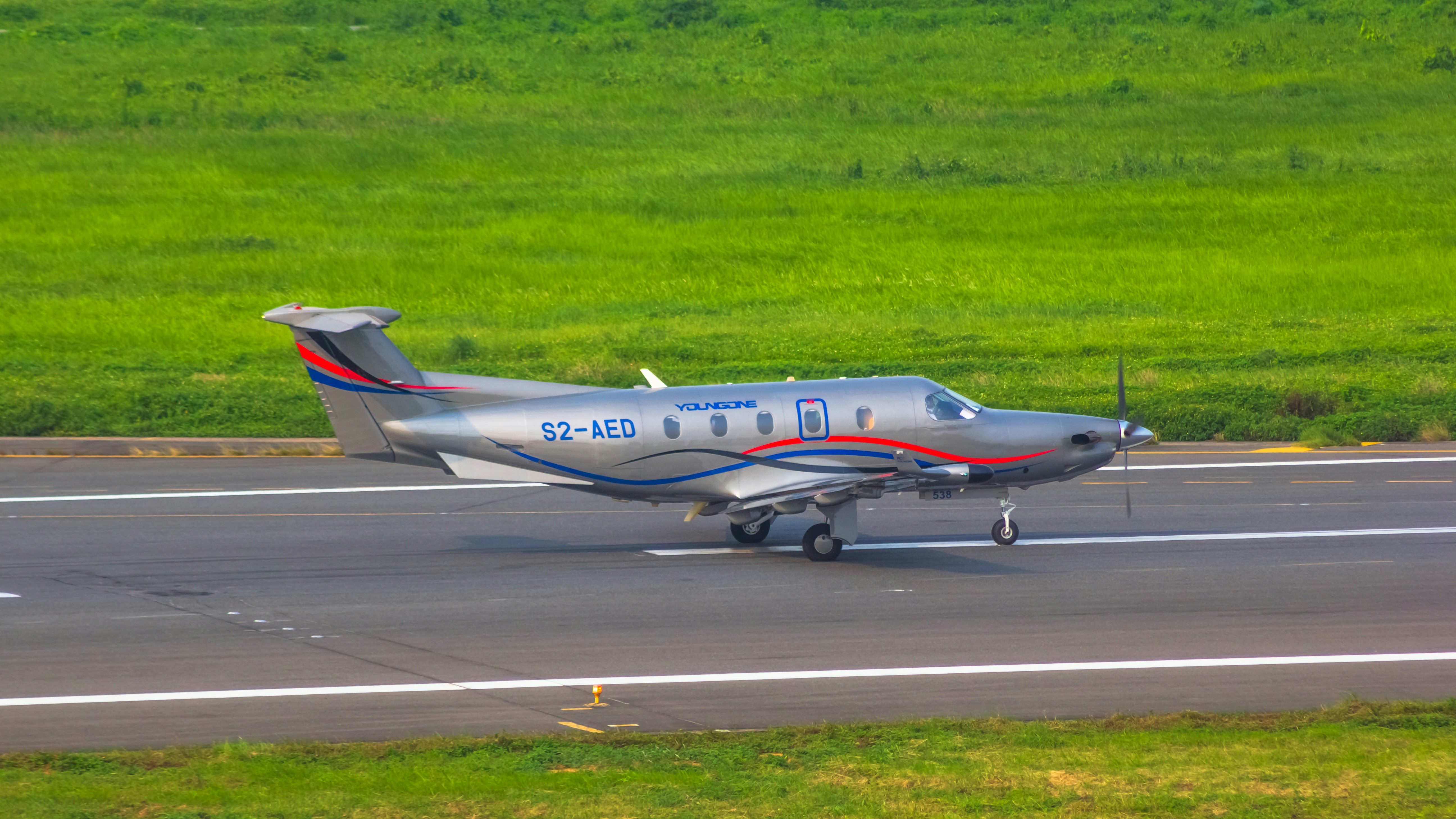 A small silver airplane is on the runway photo – Free Aircraft Image on ...