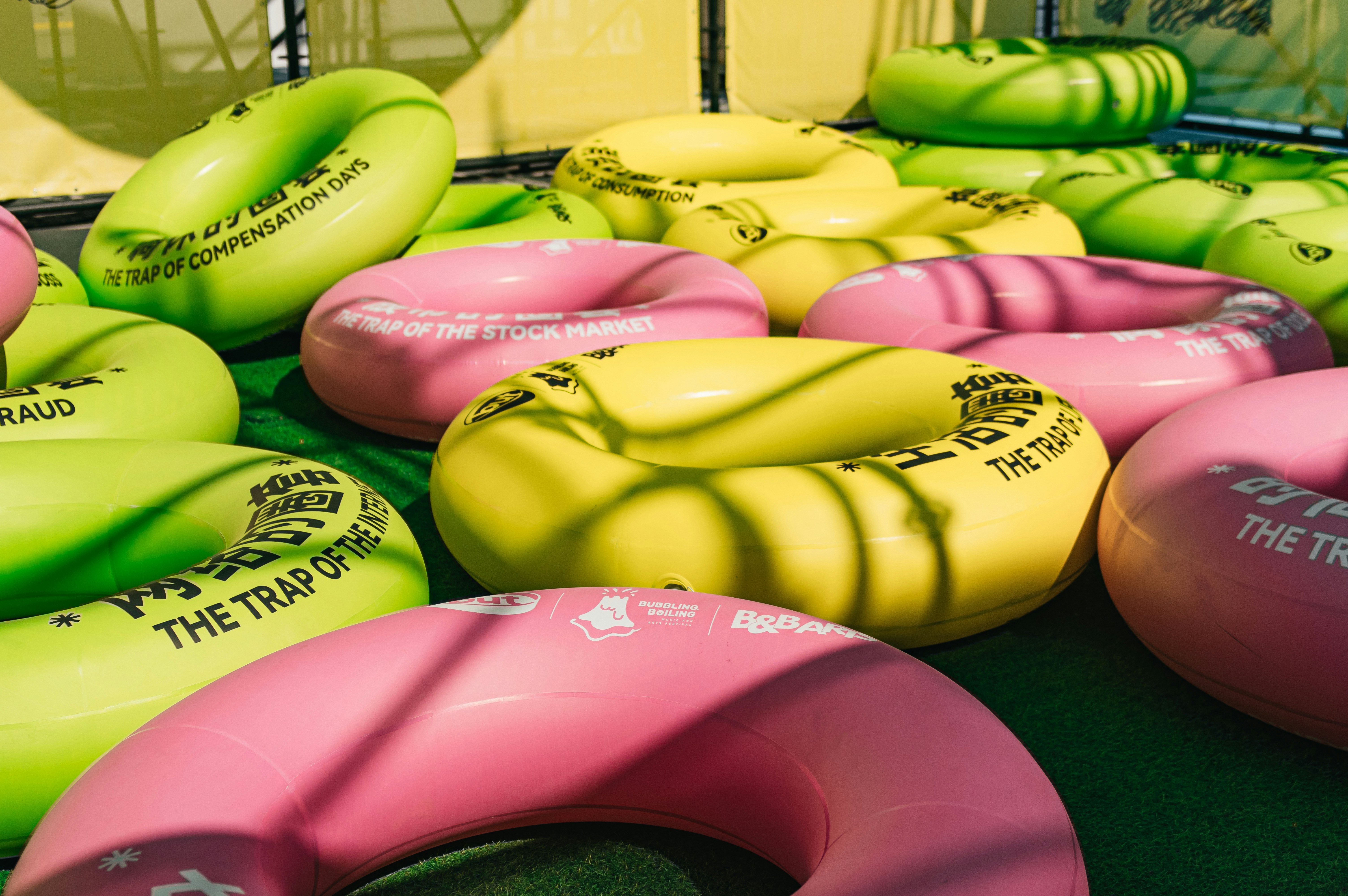 A bunch of inflatables sitting on the ground photo – Free Decoration ...