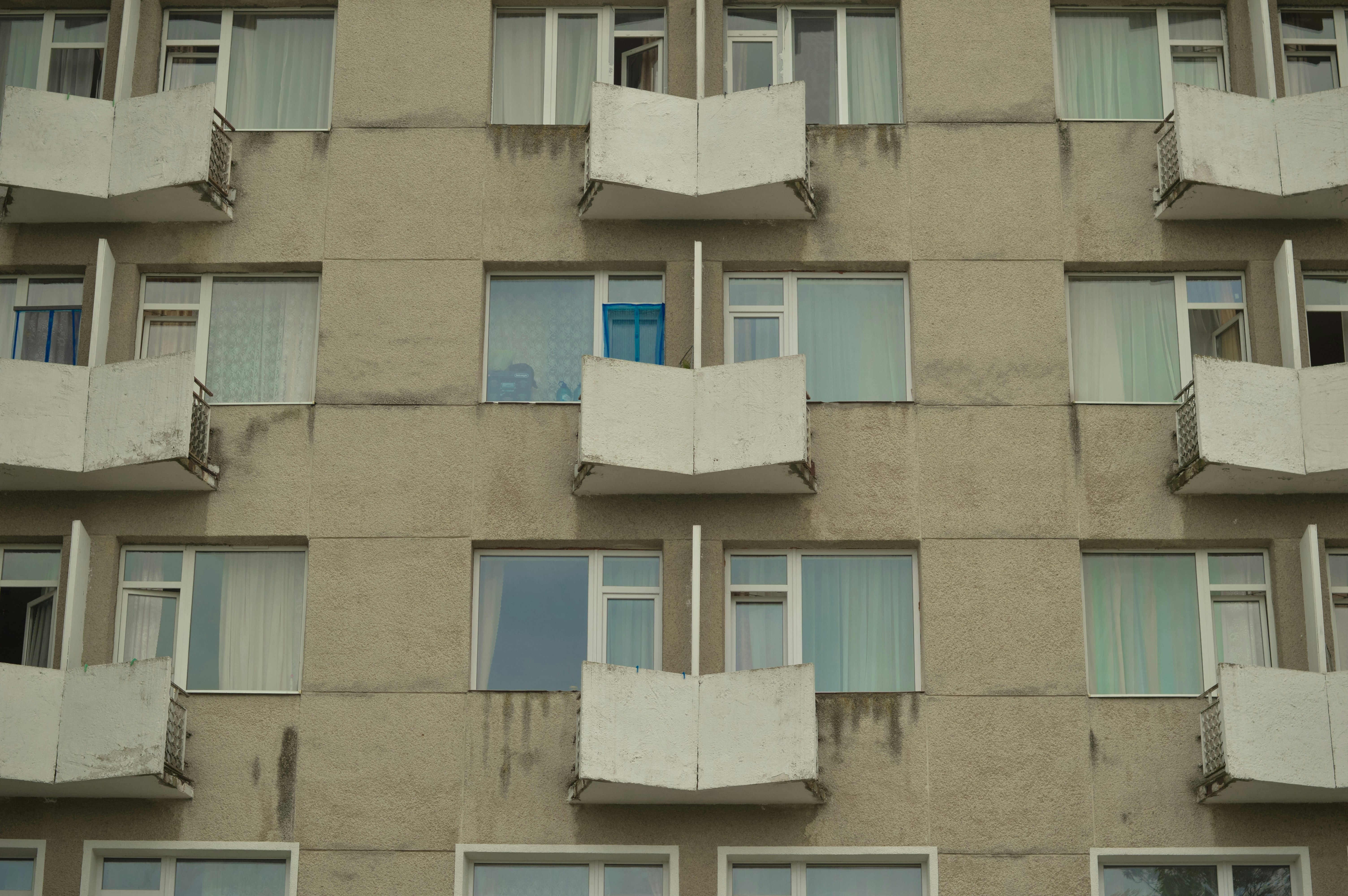 A very tall building with many windows and balconies photo – Free Grey ...