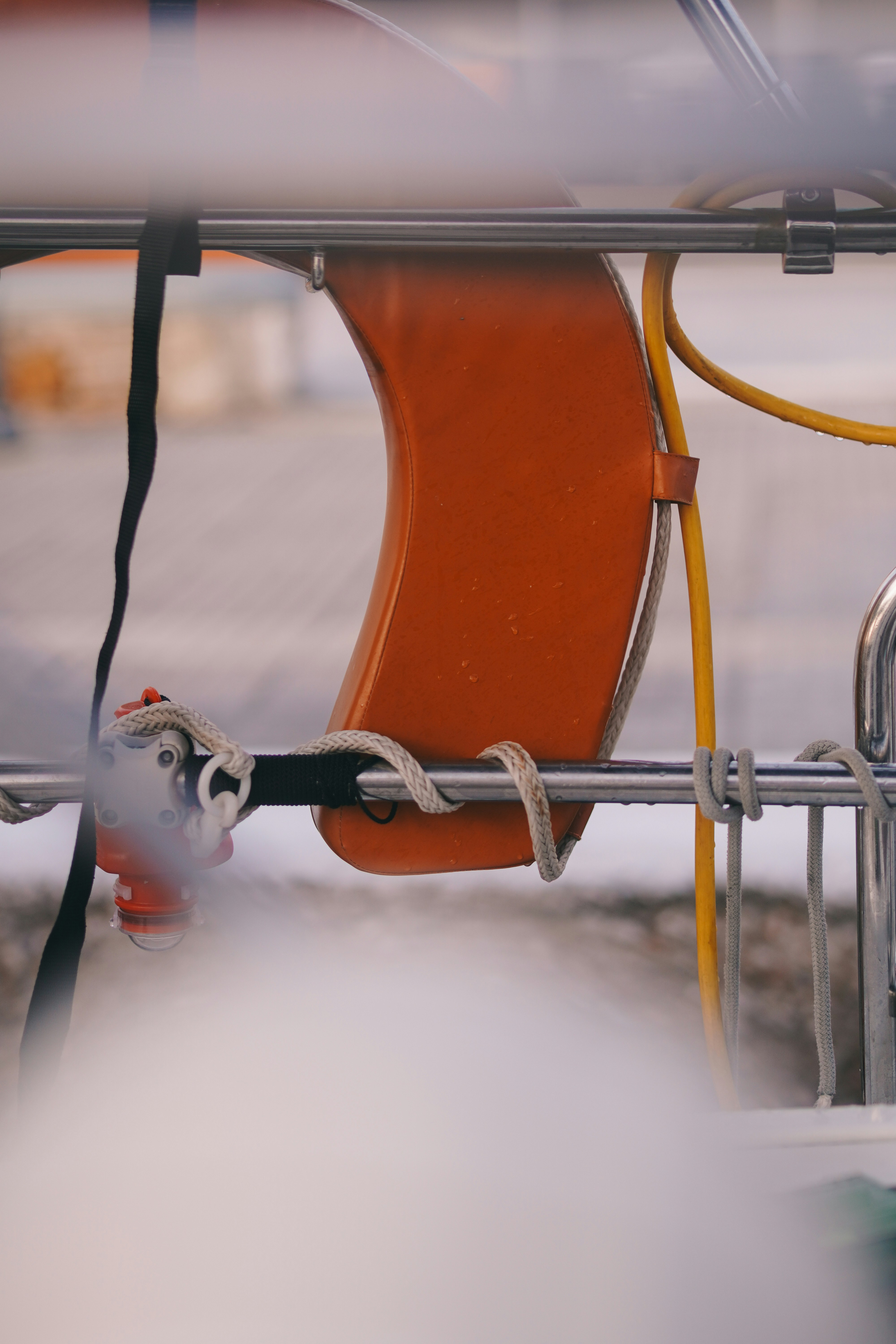 A close up of a metal railing with a fire hydrant in the background ...