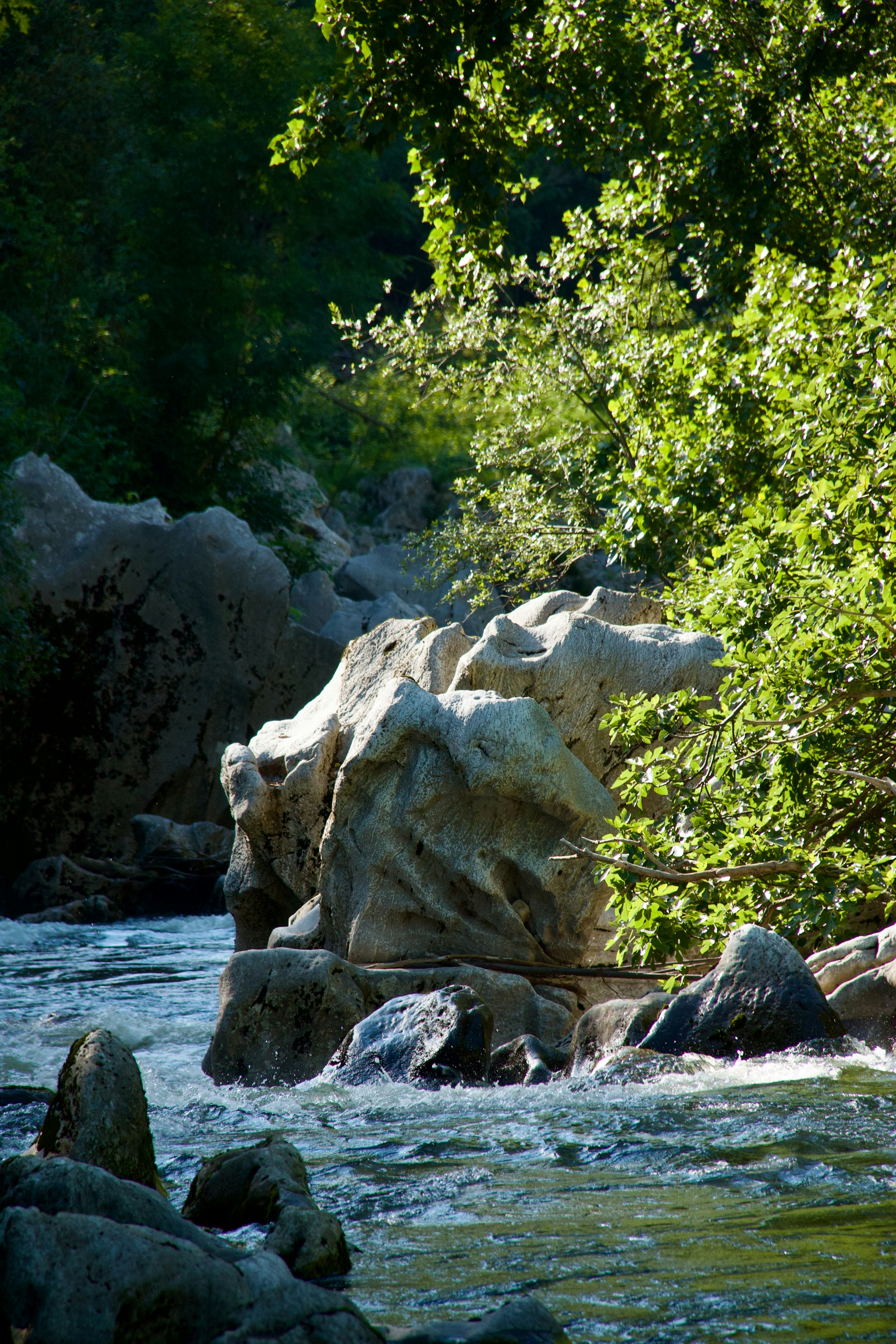 Sunlit Granite Verge by a Quiet River