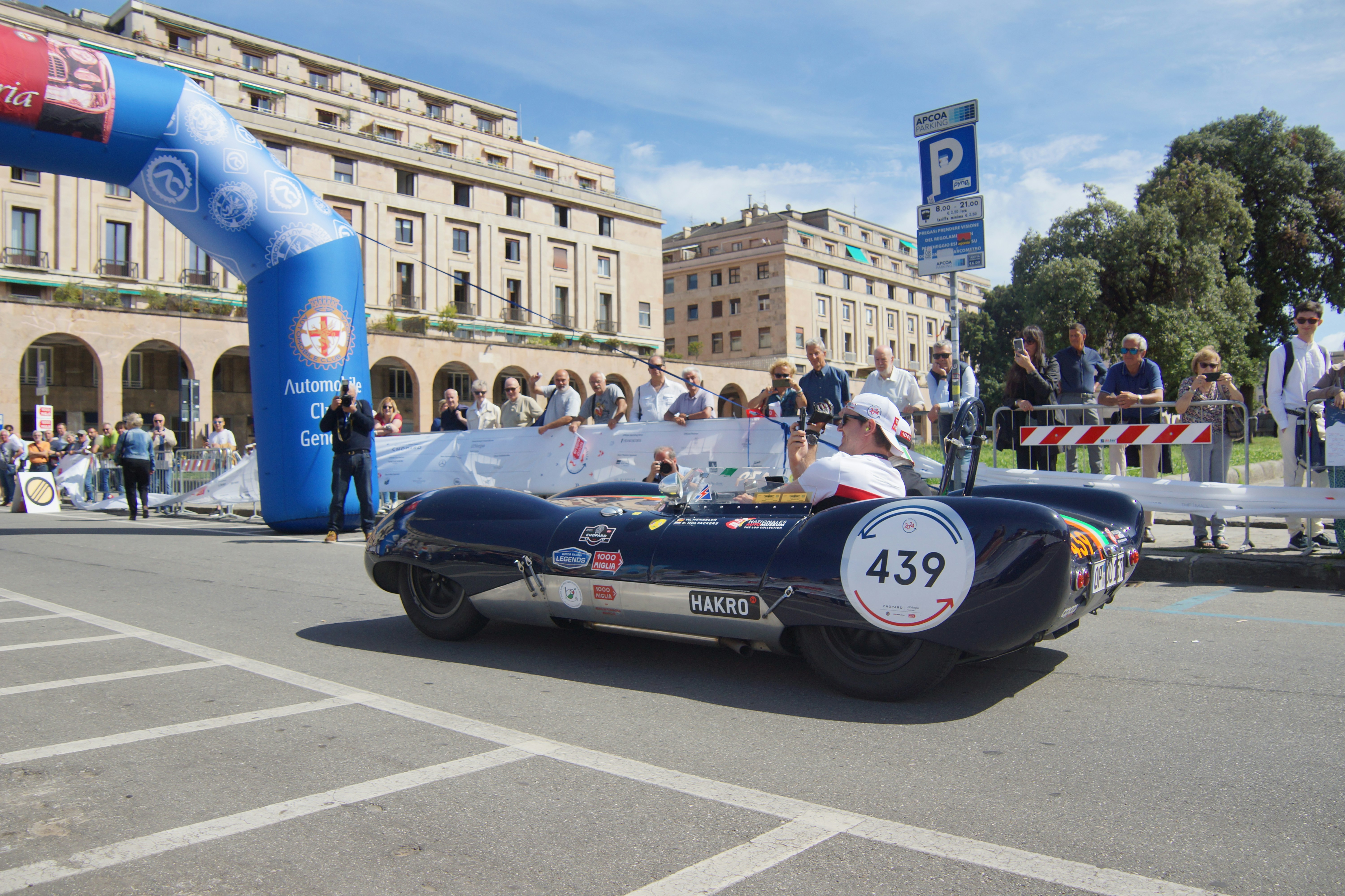 A man driving a race car down a street photo – Free Genova ...