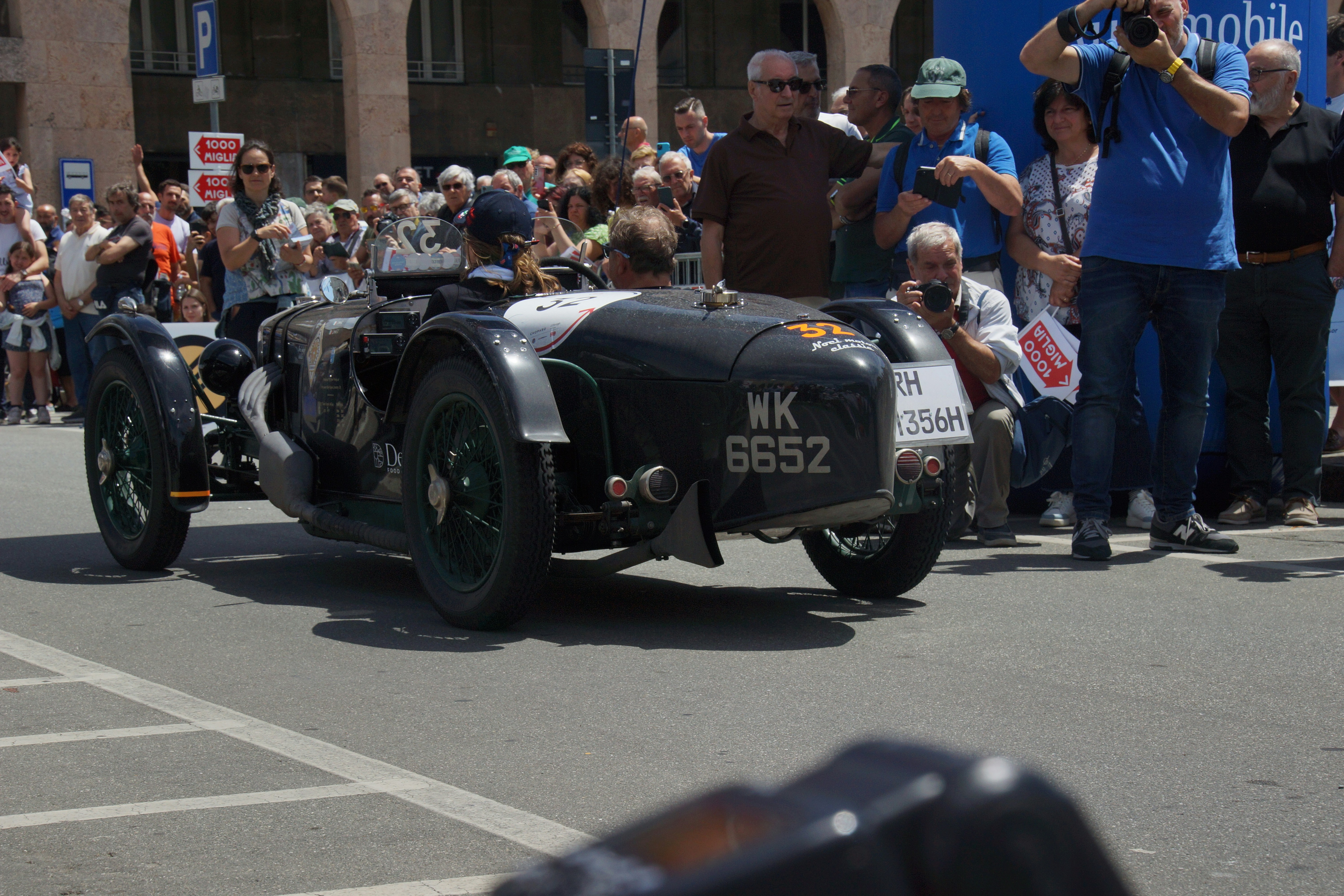 A vintage race car driving down a street photo – Free Genova ...
